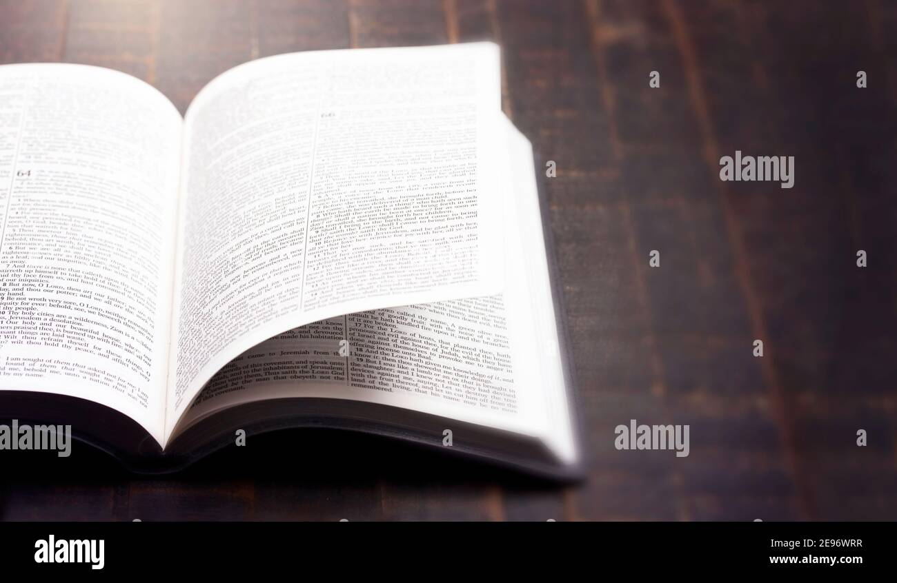Bible Open on a Rustic Wooden Table with Pages Blowing Open Stock Photo ...