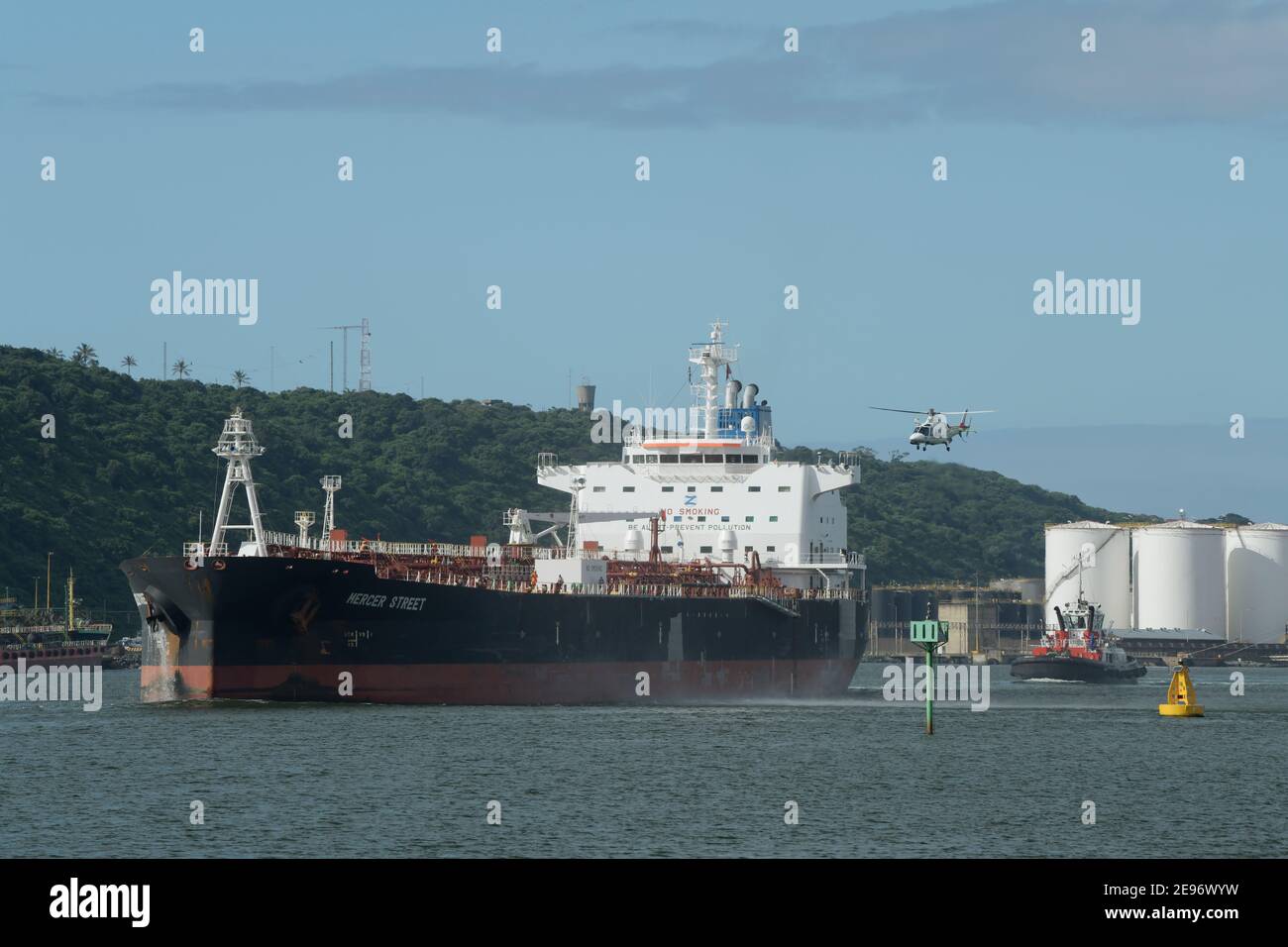 Harbour industry, helicopter flying next to cargo ship Mercer Street ...