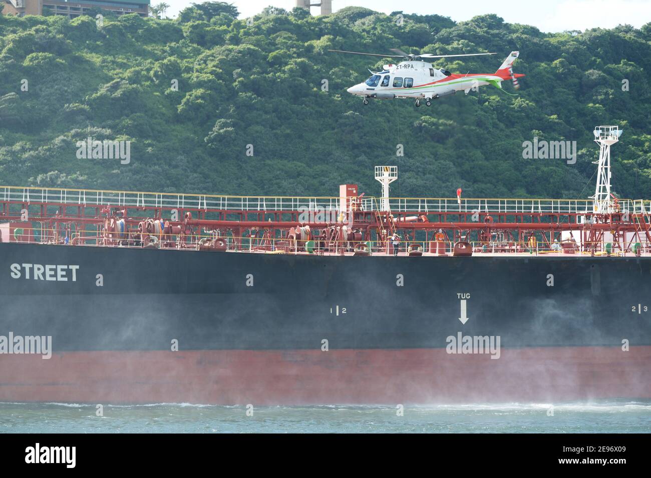 Helicopter flying, aircraft of Transnet port authority hoisting man ...