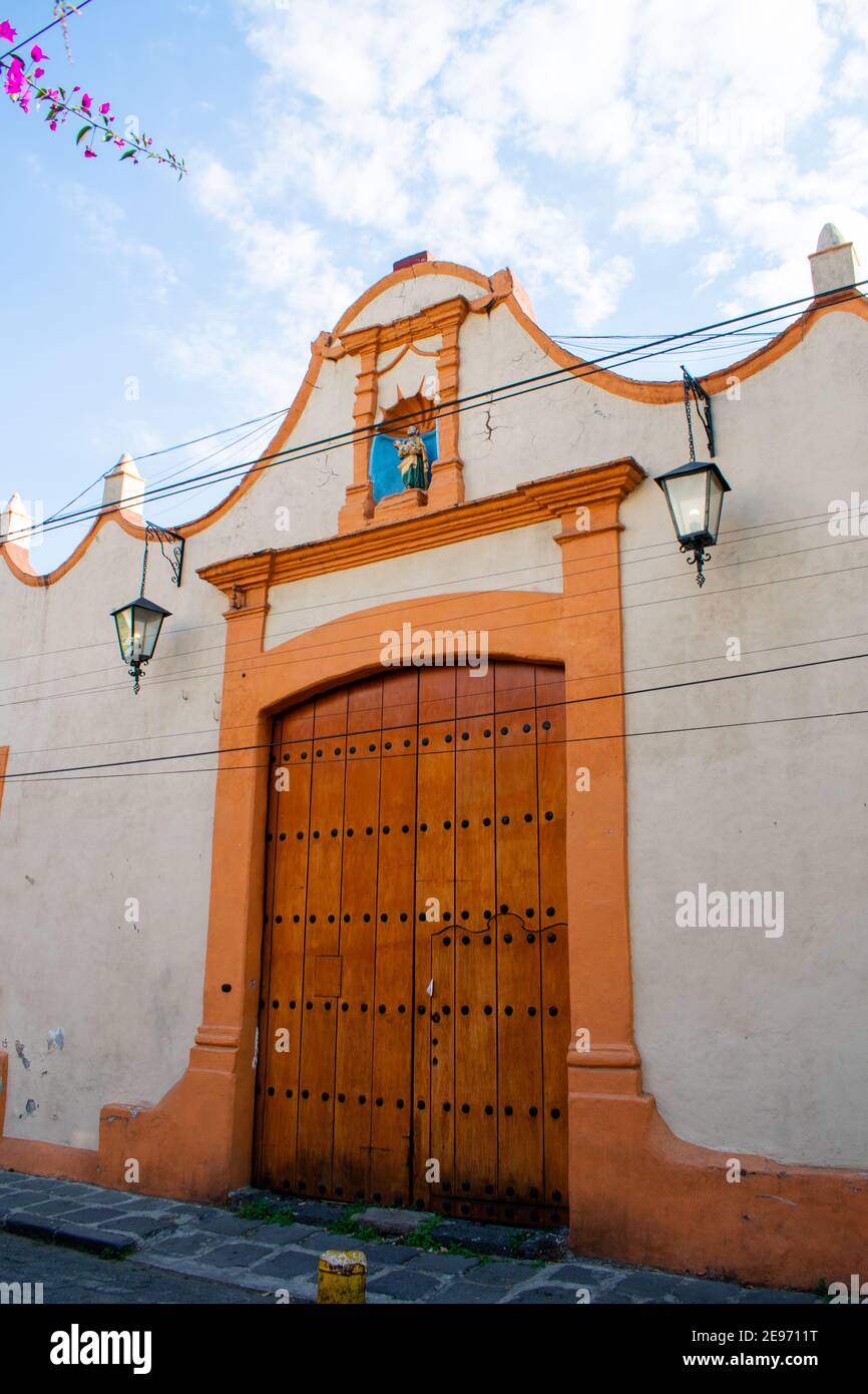 Hispanic building with small religious altar above the tall door Stock ...