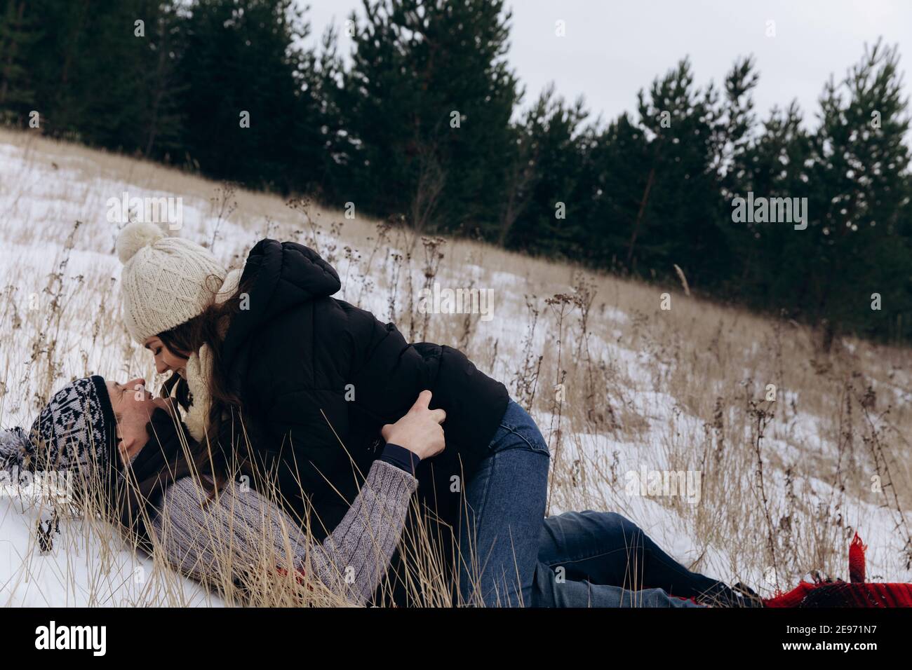 The woman dropped the man into the snow Stock Photo - Alamy