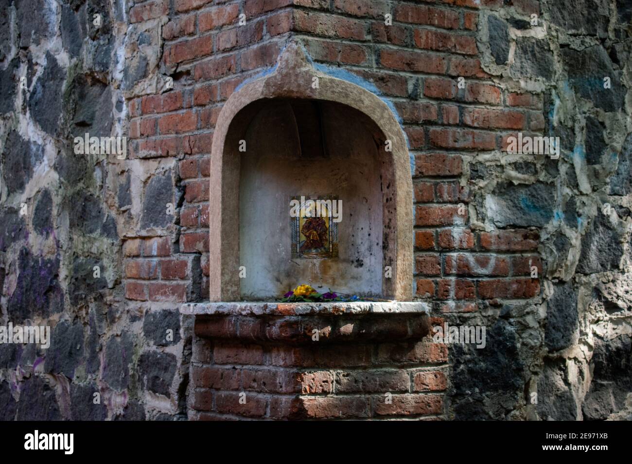 Small altar on the corner of a stone wall Stock Photo - Alamy