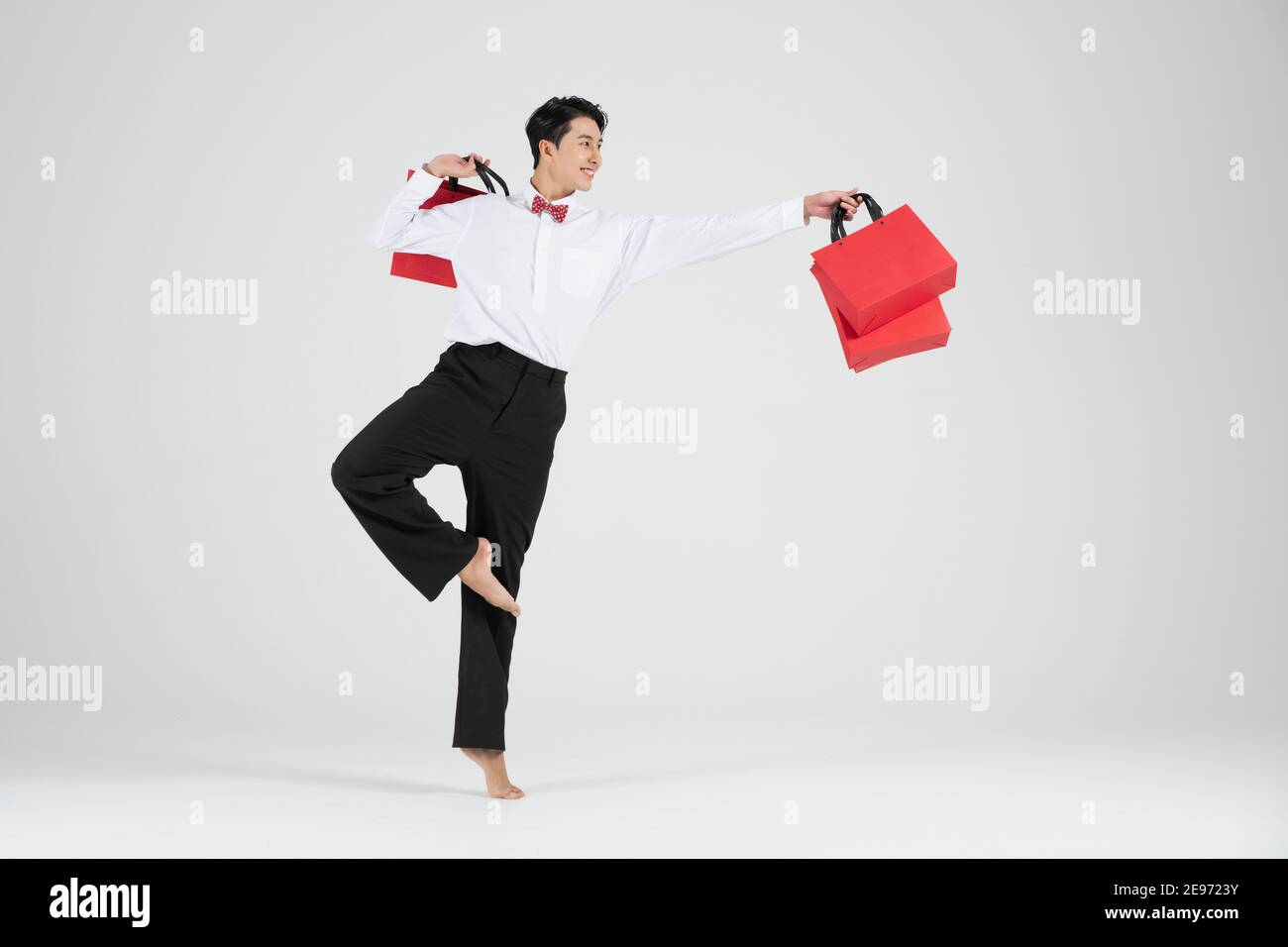 sale promotion concept, contemporary male dancer with shopping bags ...