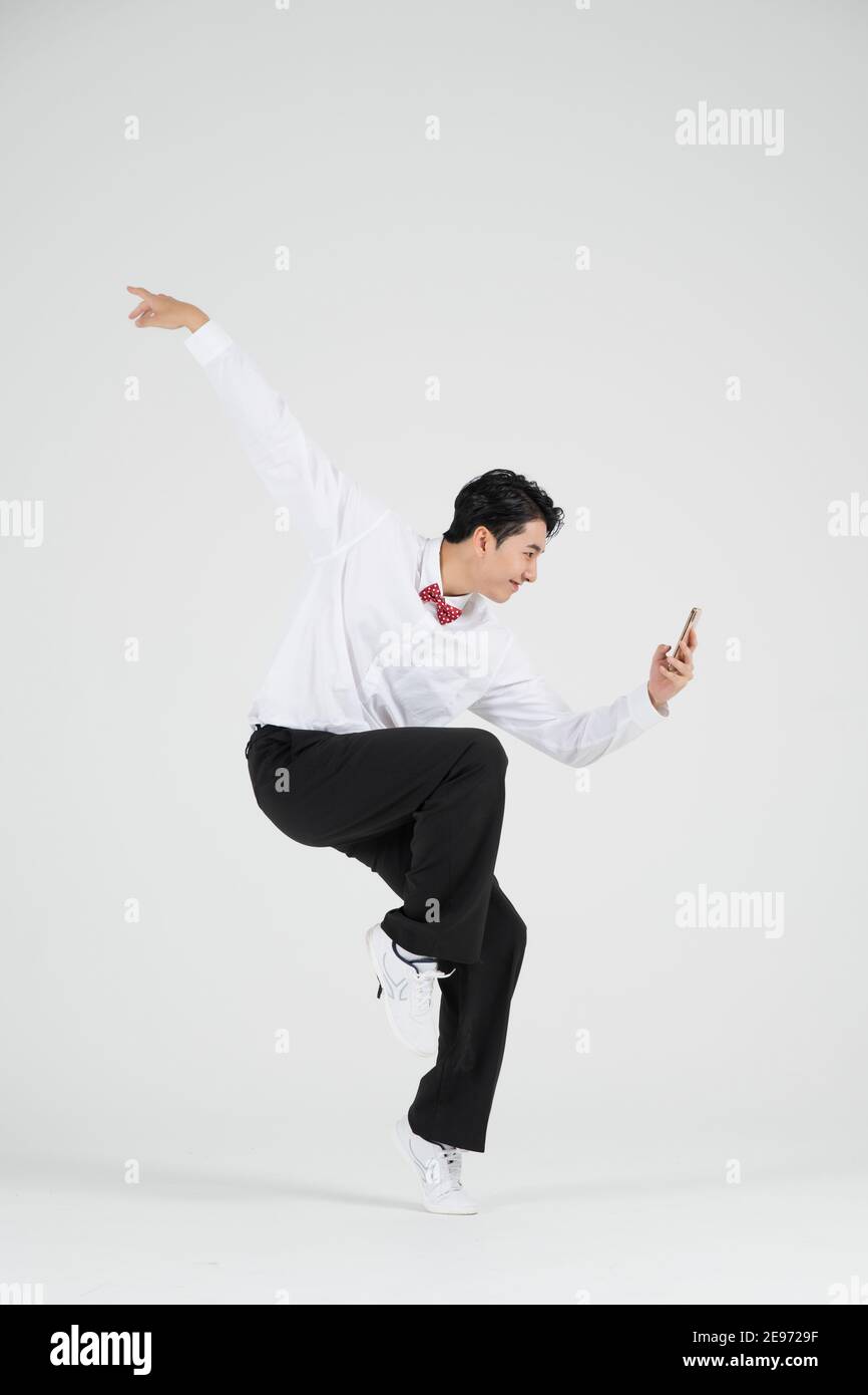 sale promotion concept, contemporary male dancer with smarphone on hand ...