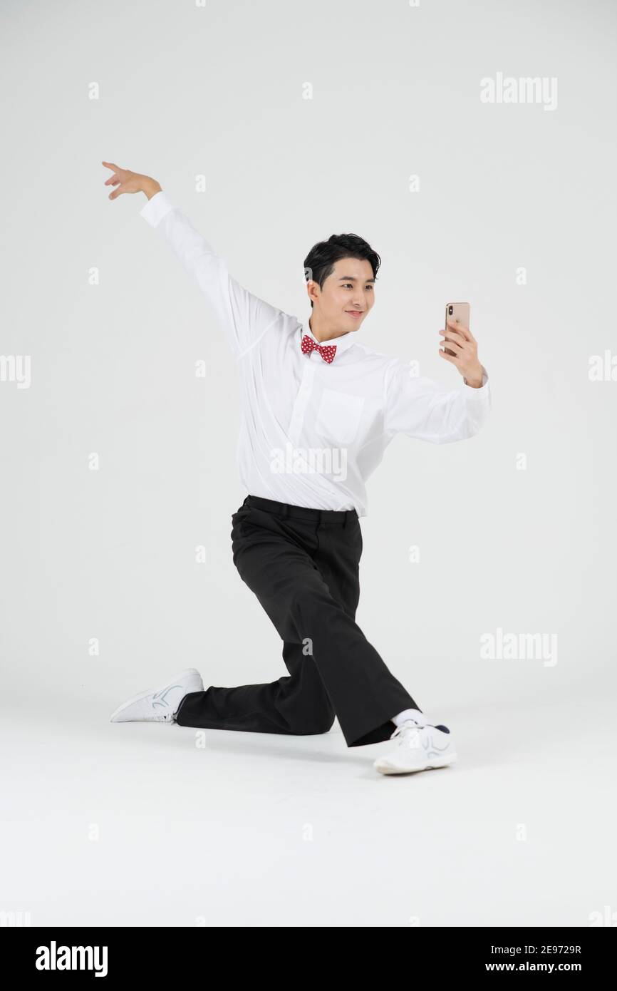 sale promotion concept, contemporary male dancer with smarphone on hand ...