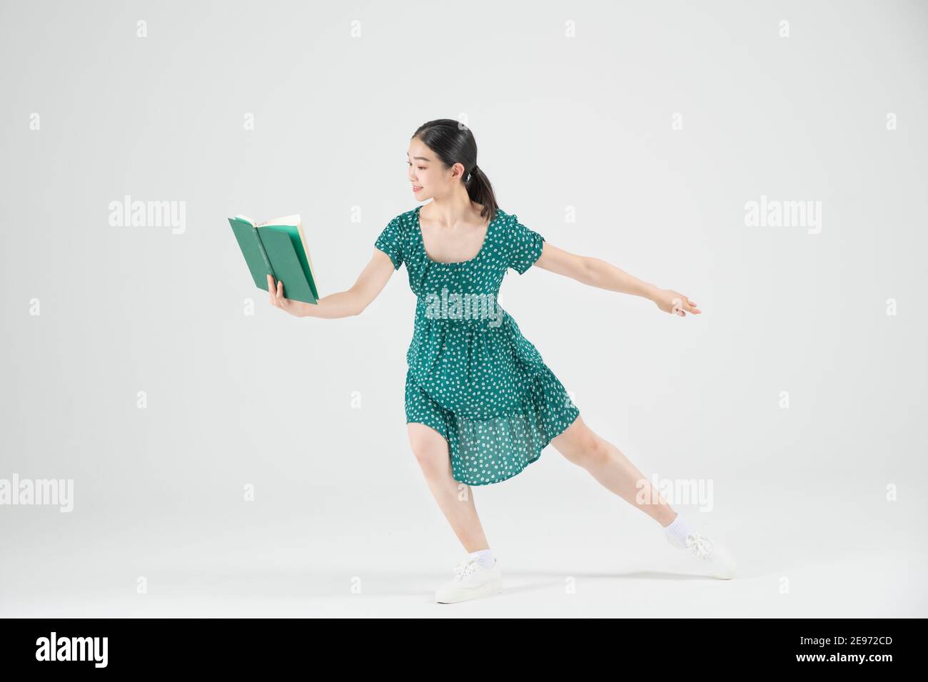Asian female contemporary dancer holding book Stock Photo - Alamy