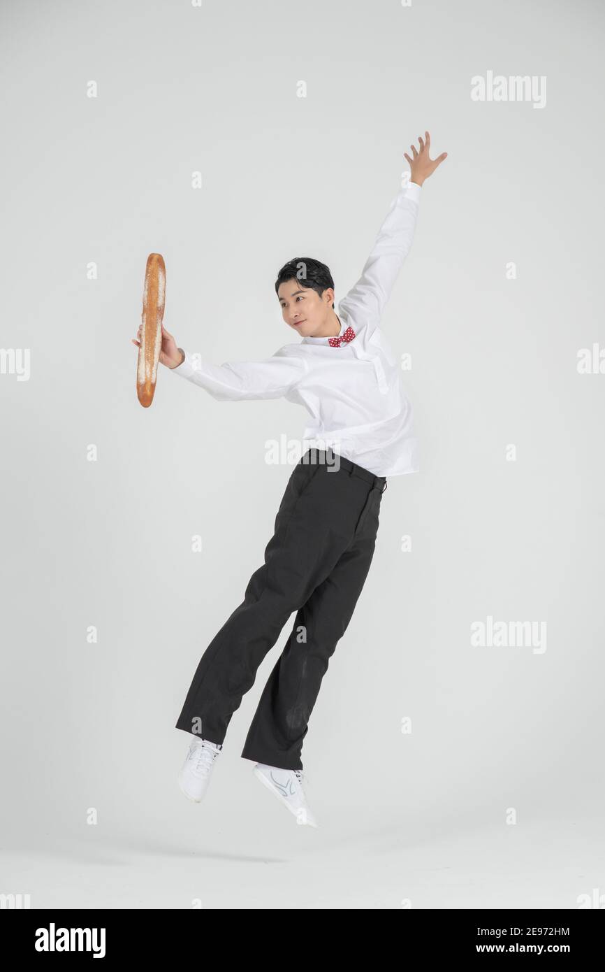 Asian male contemporary dancer holding bread Stock Photo - Alamy
