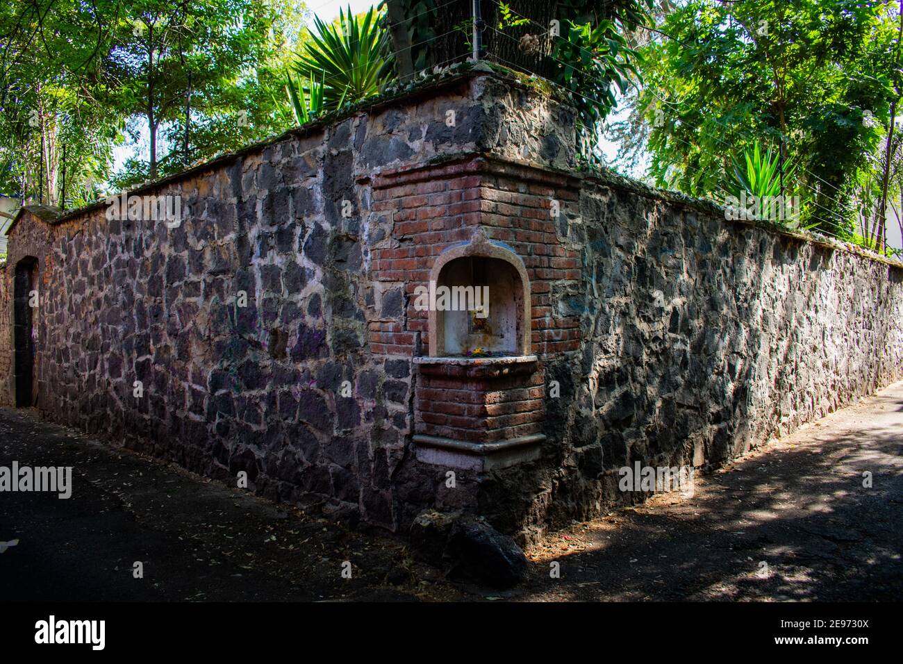 Small altar on the corner of a stone wall Stock Photo - Alamy