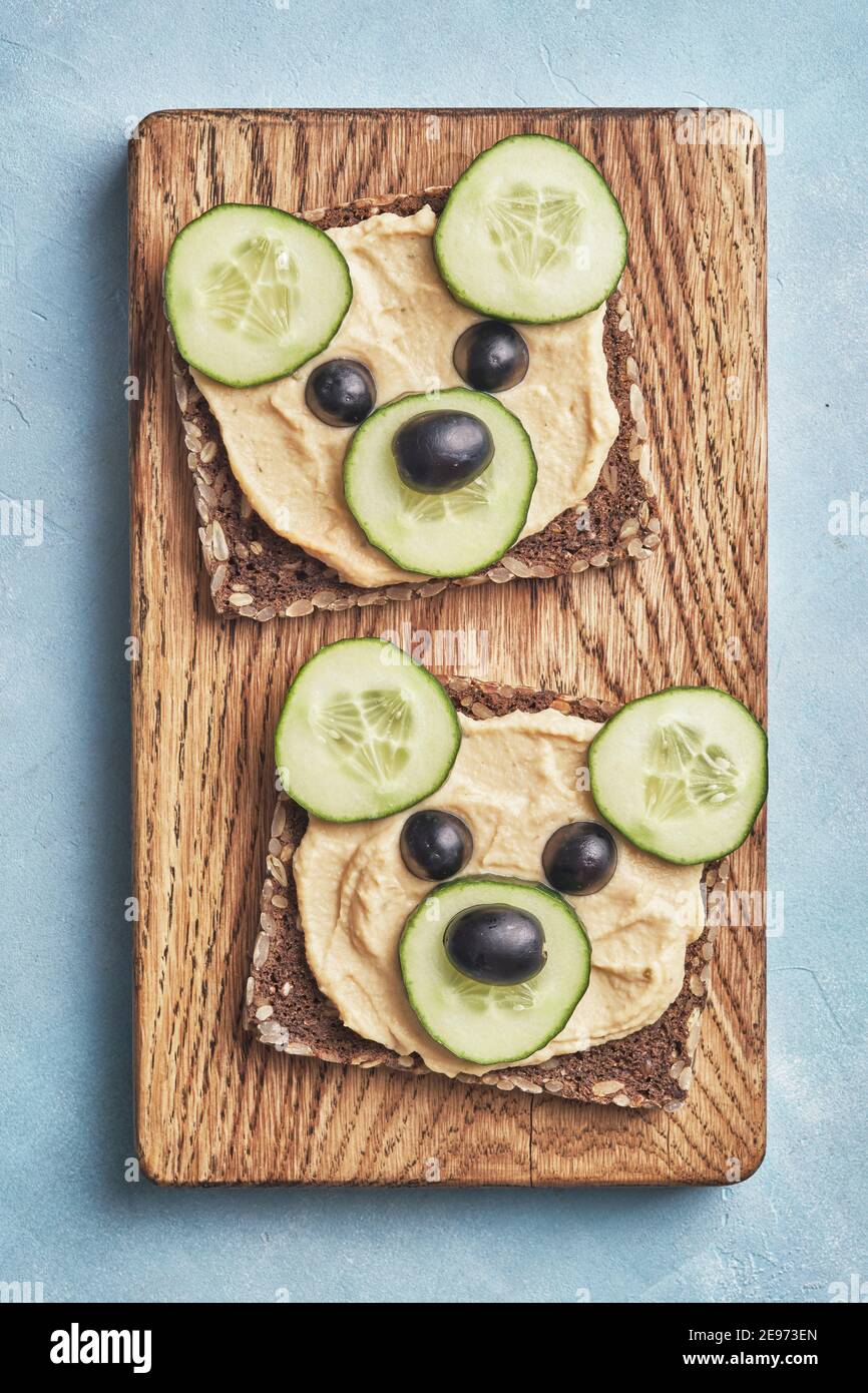 Funny bear toast with cucumber and hummus toasts Stock Photo - Alamy