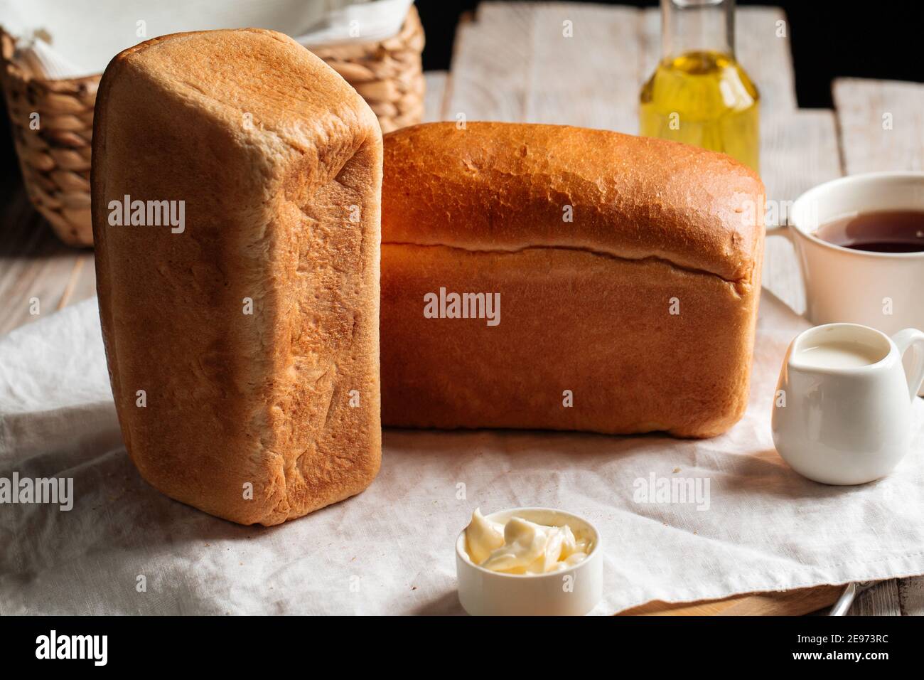 Loafs of white brick shaped bread with butter Stock Photo - Alamy