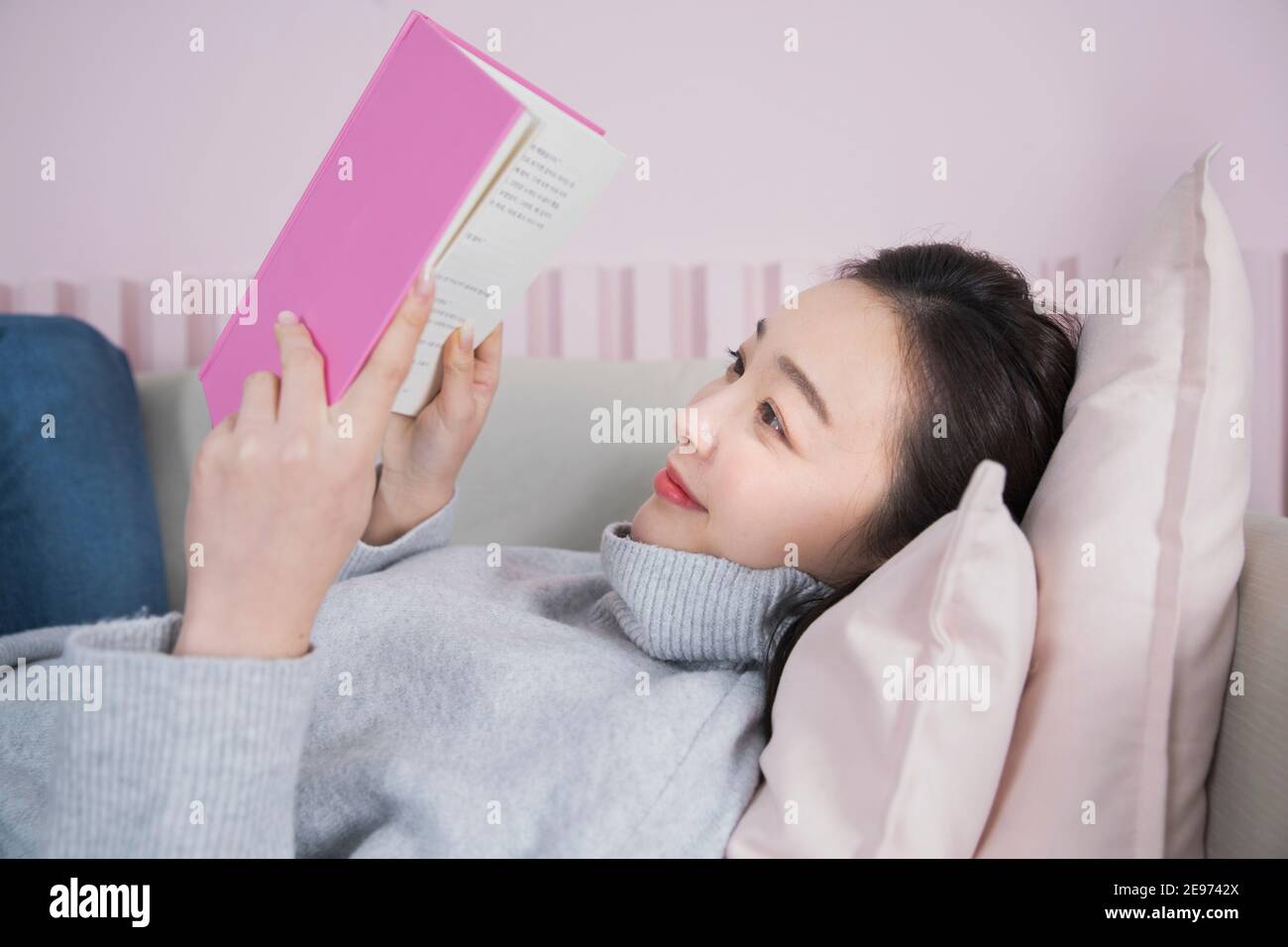 Asian single solo woman living alone concept reading book on couch ...