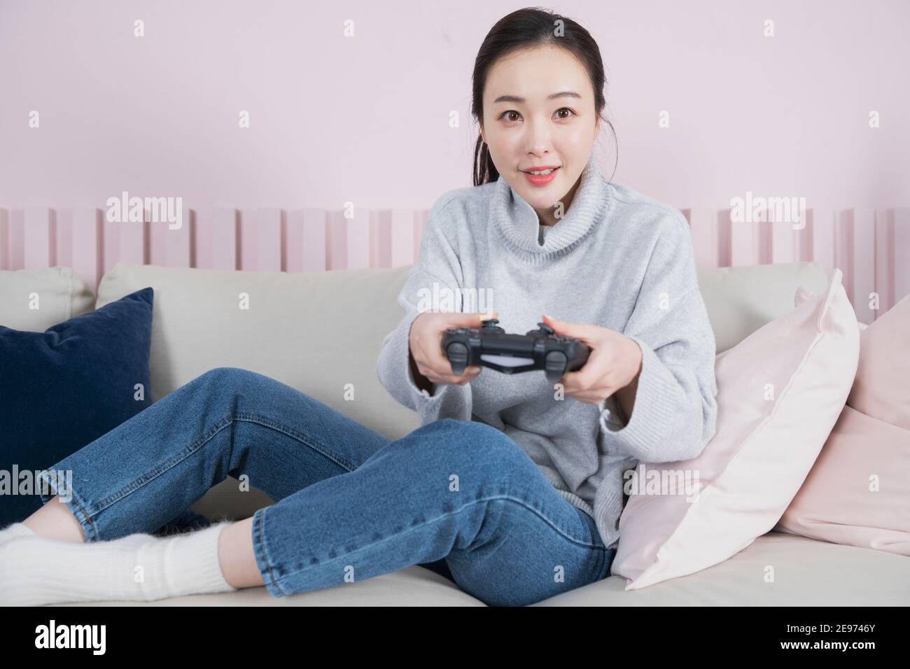 single solo woman living alone concept playing game with console Stock ...