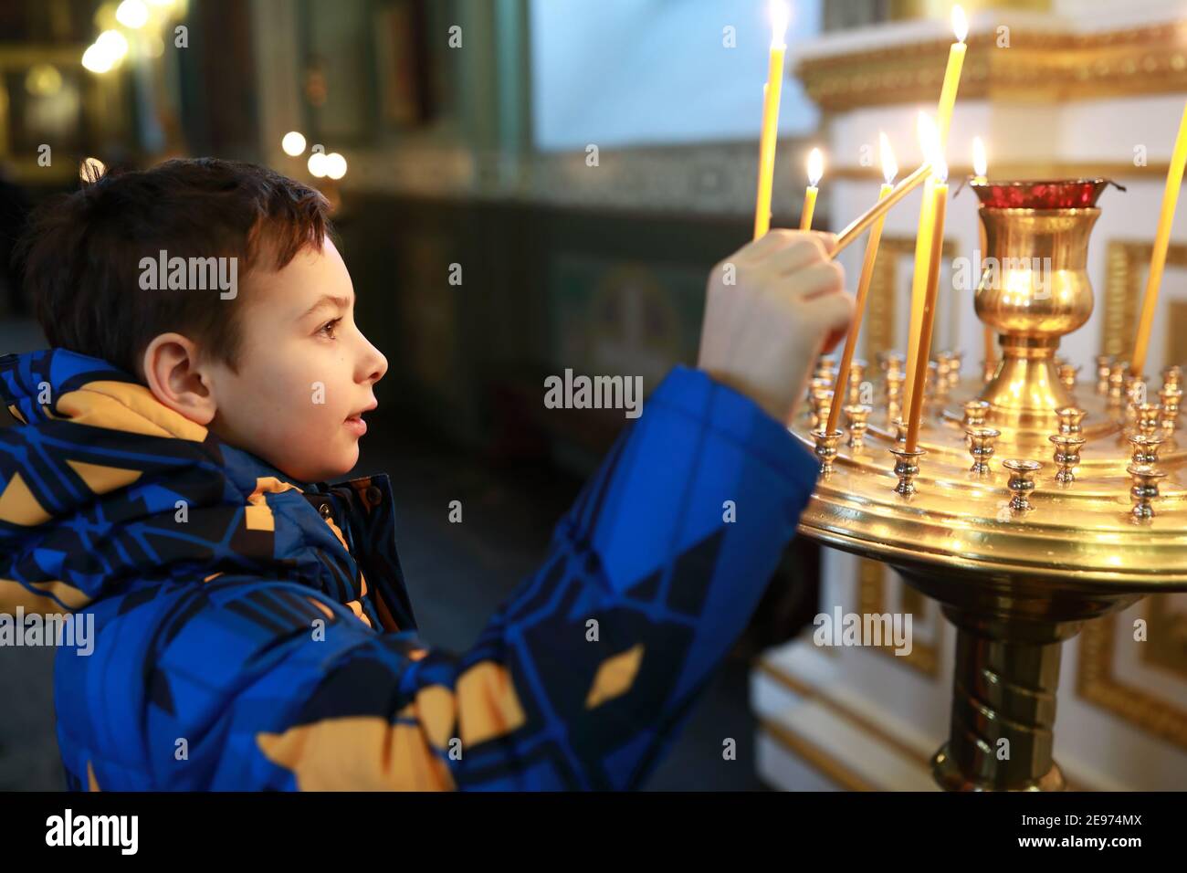 Portrait of child with lit candle in cathedral Stock Photo - Alamy