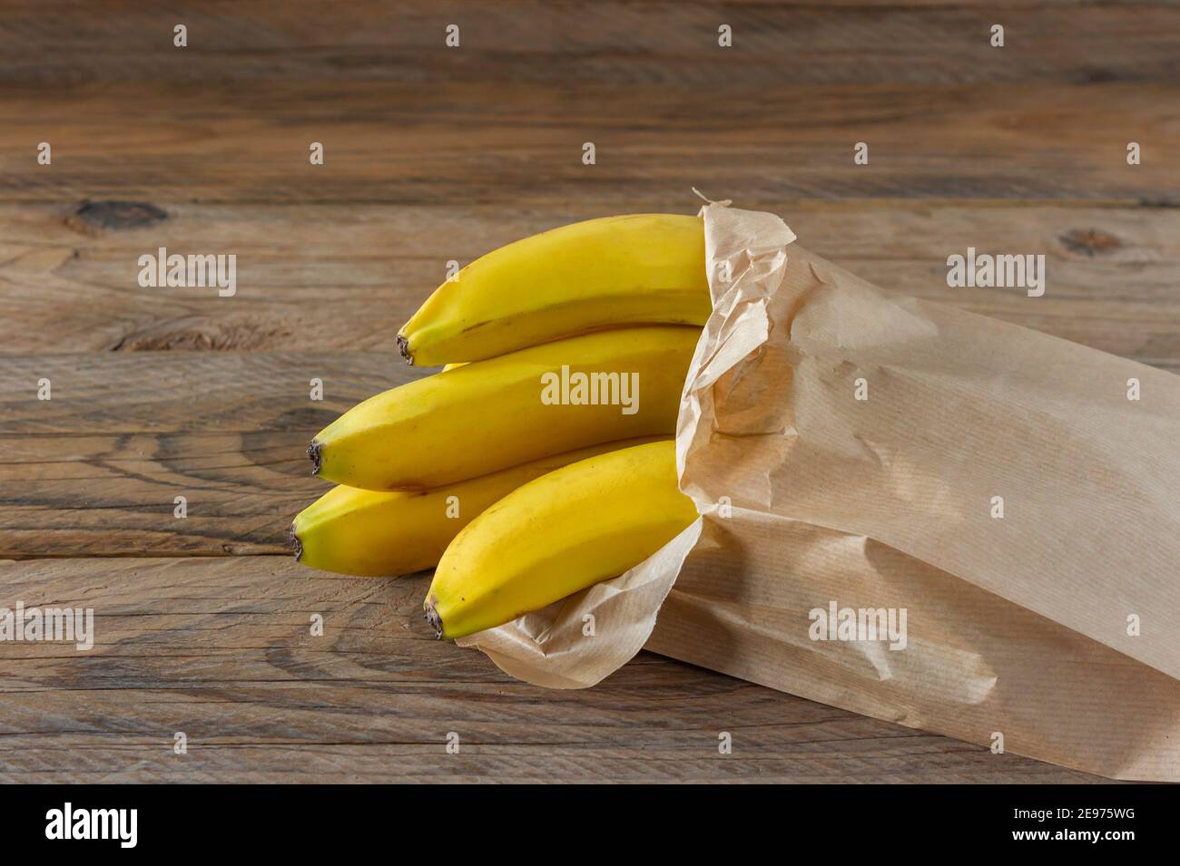 Ripe bunch of bananas in paper bag. Healthy eating concept Stock Photo ...