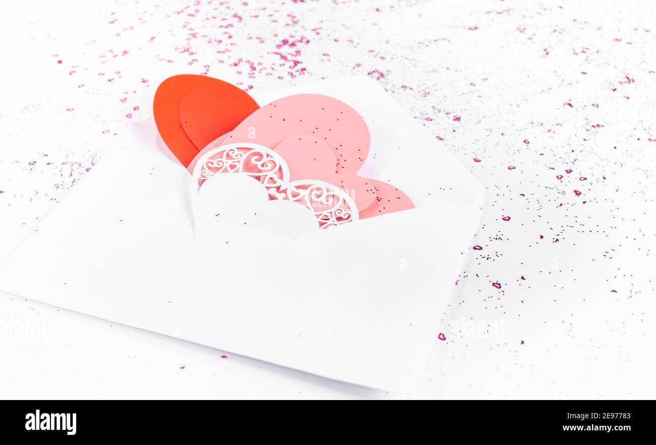 Love letter, envelope with paper craft hearts on background with ...