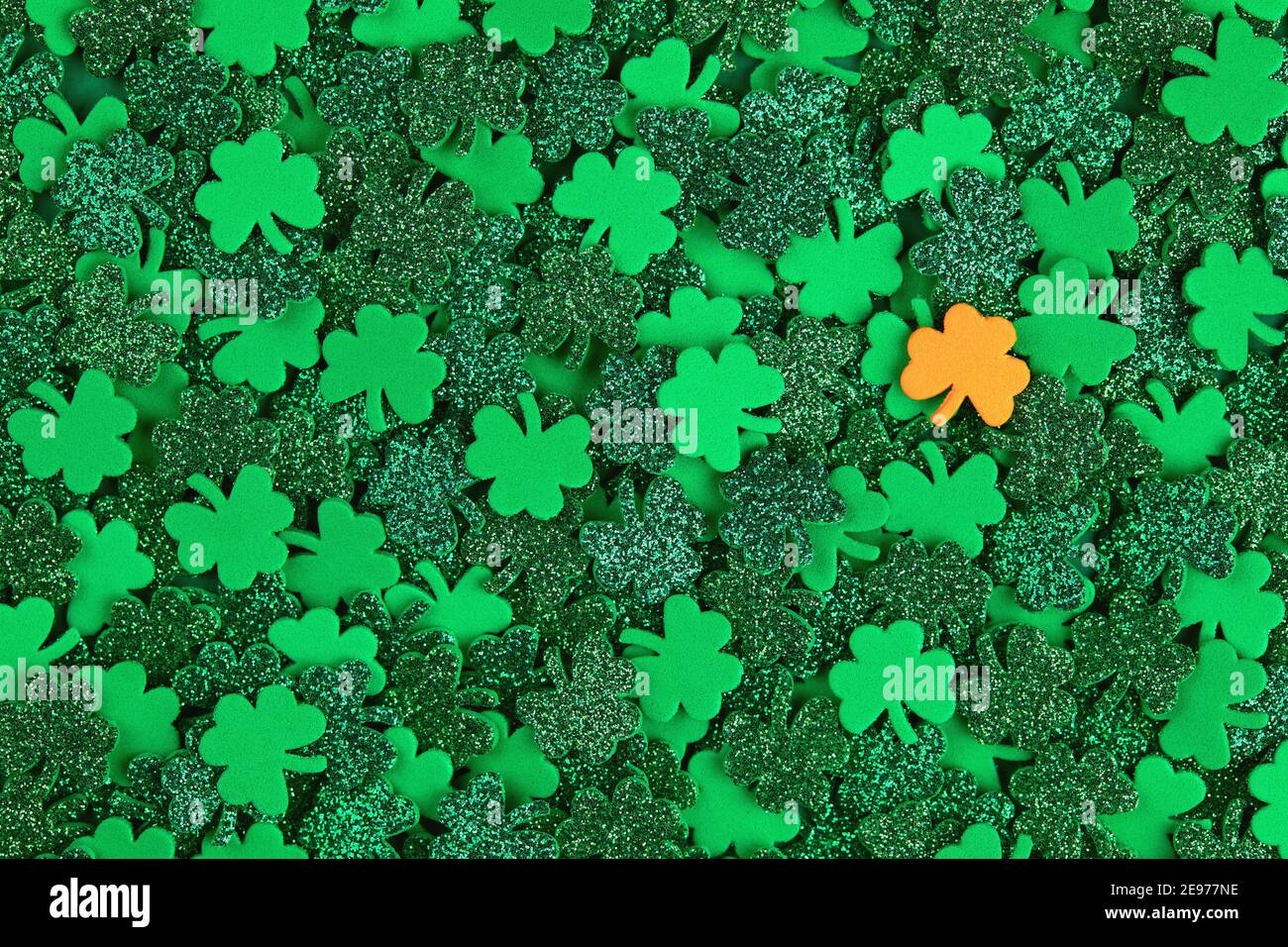 Shamrock confetti texture background with green and orange lucky ...