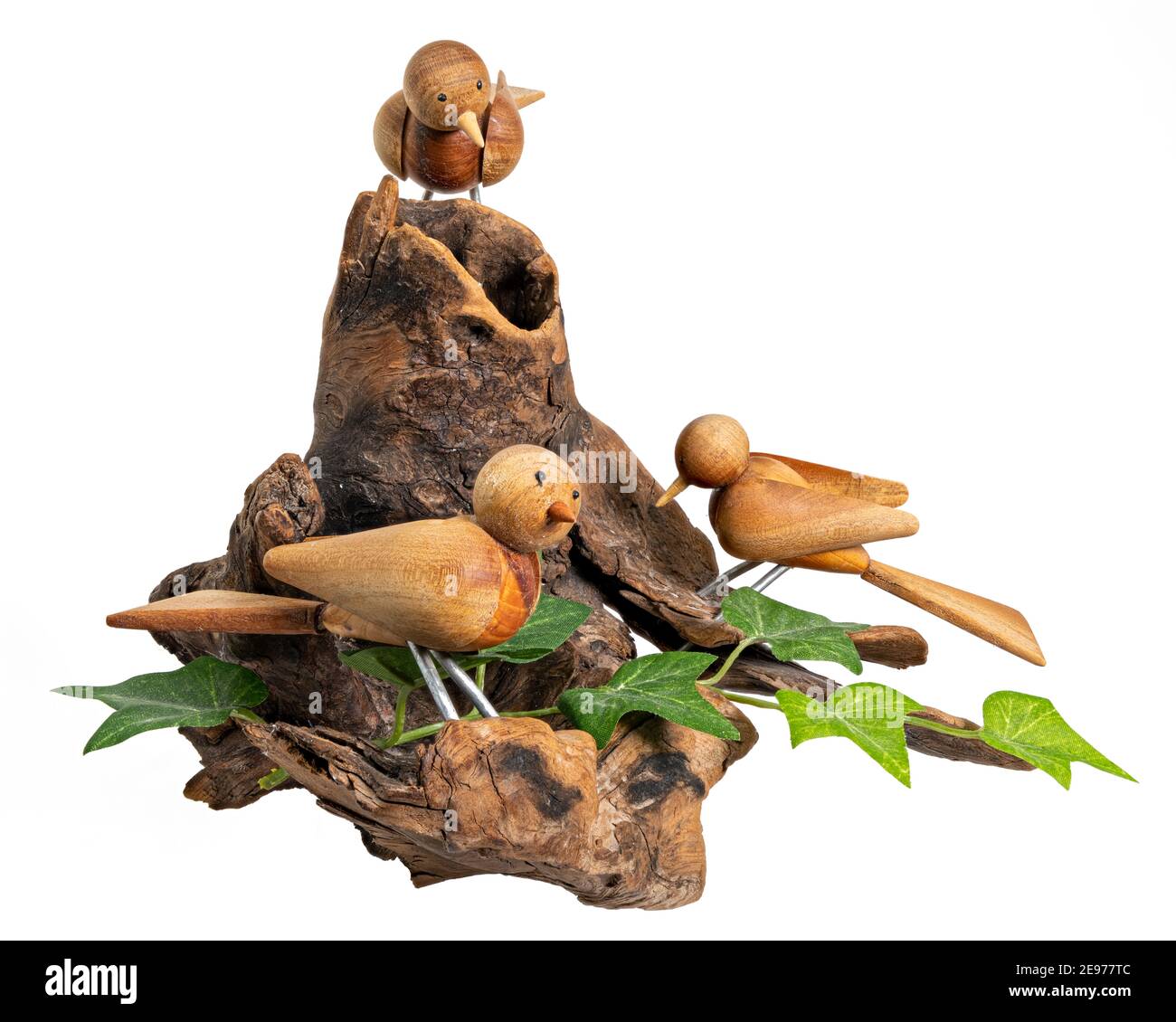 Wooden model with 3 turned birds on a tree root, isolated on white ...
