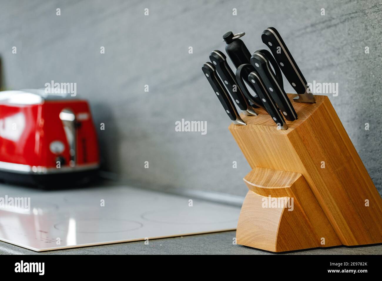 Set of knives on stand on kitchen counter Stock Photo - Alamy
