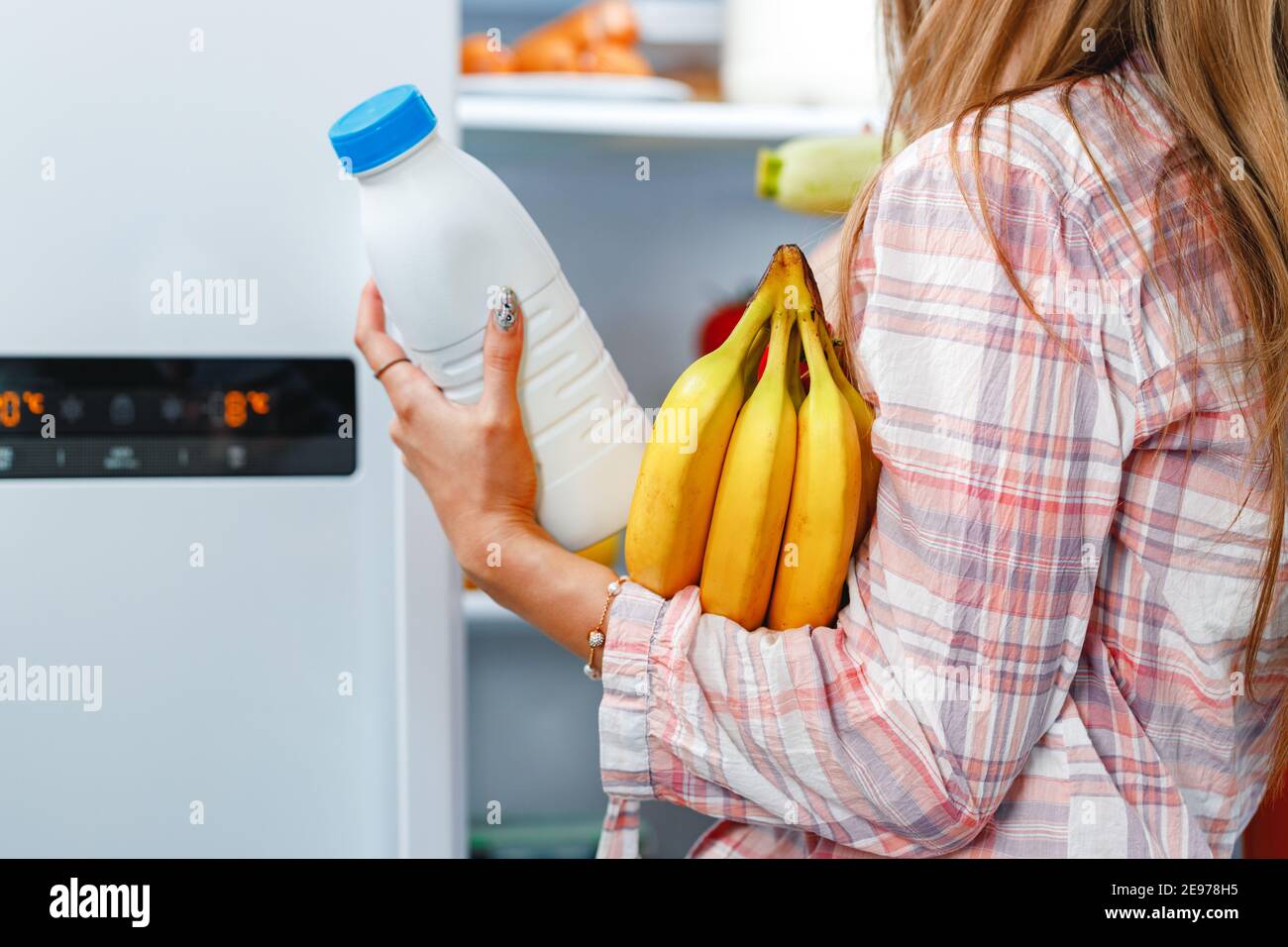 Woman opening fridge door hi-res stock photography and images - Alamy
