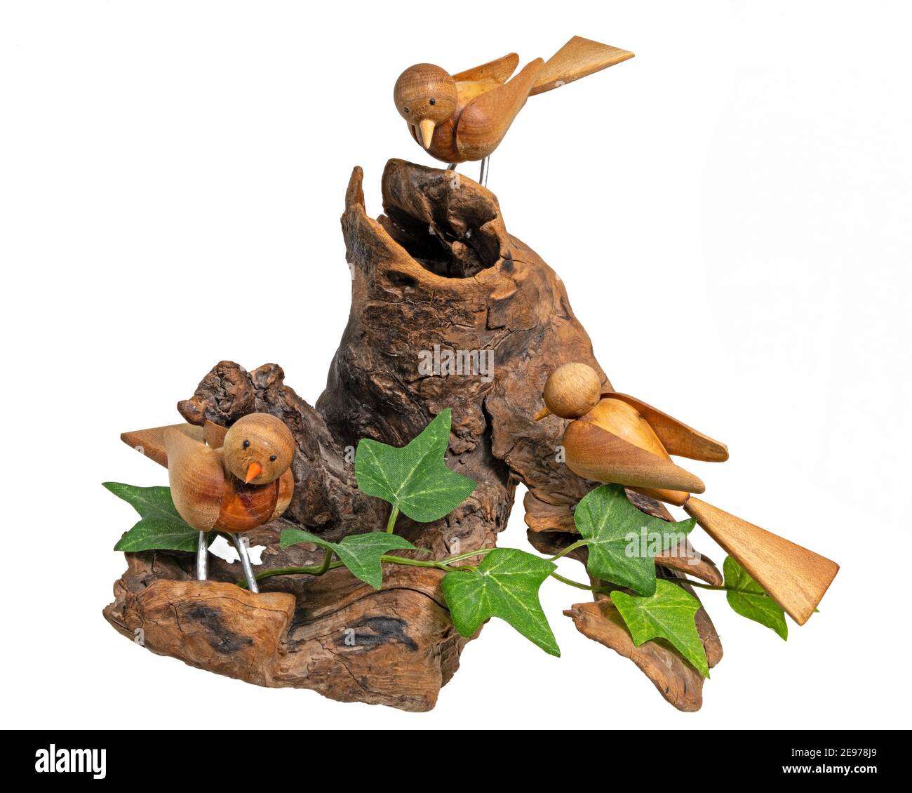Wooden model with 3 turned birds on a tree root, isolated on white ...