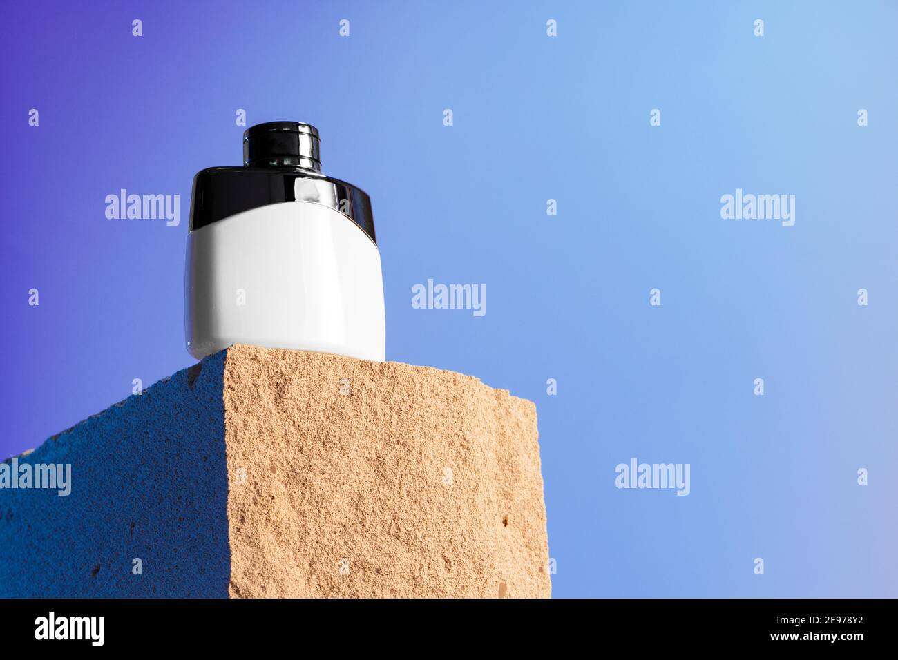 Bottle of perfume on cinder block close up Stock Photo - Alamy
