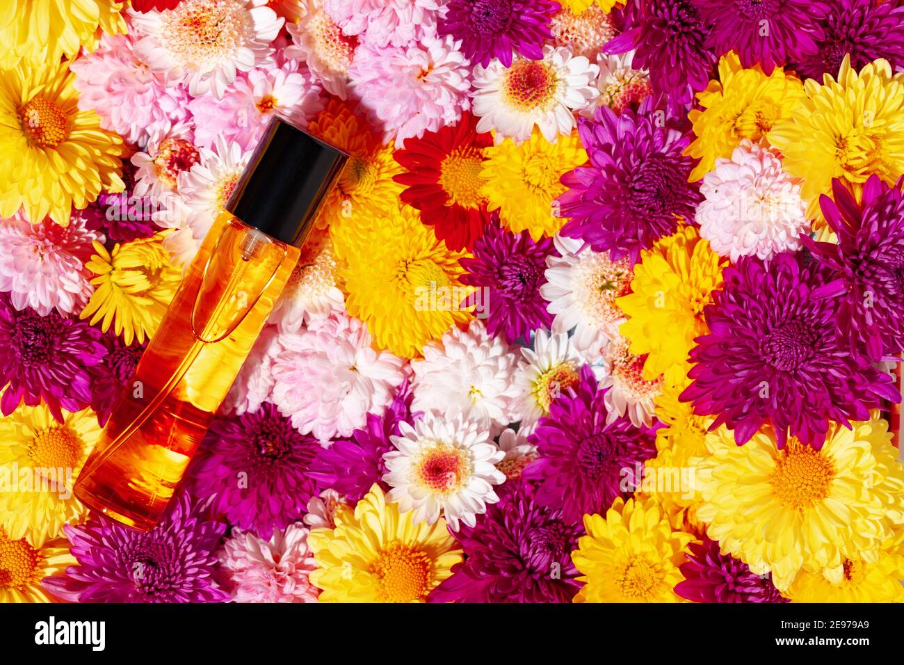 Bottle of fragrance surrounded by flower buds Stock Photo - Alamy