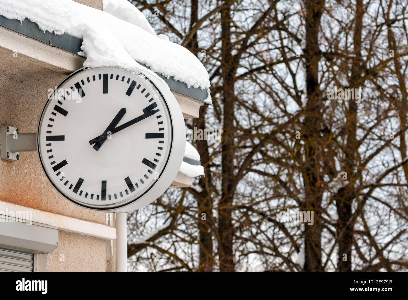 Large clock on the outside of a building during winter season Stock ...