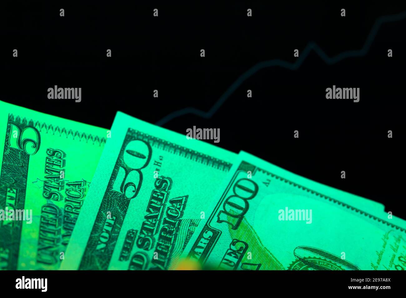 American dollar banknotes and graph on black background Stock Photo - Alamy