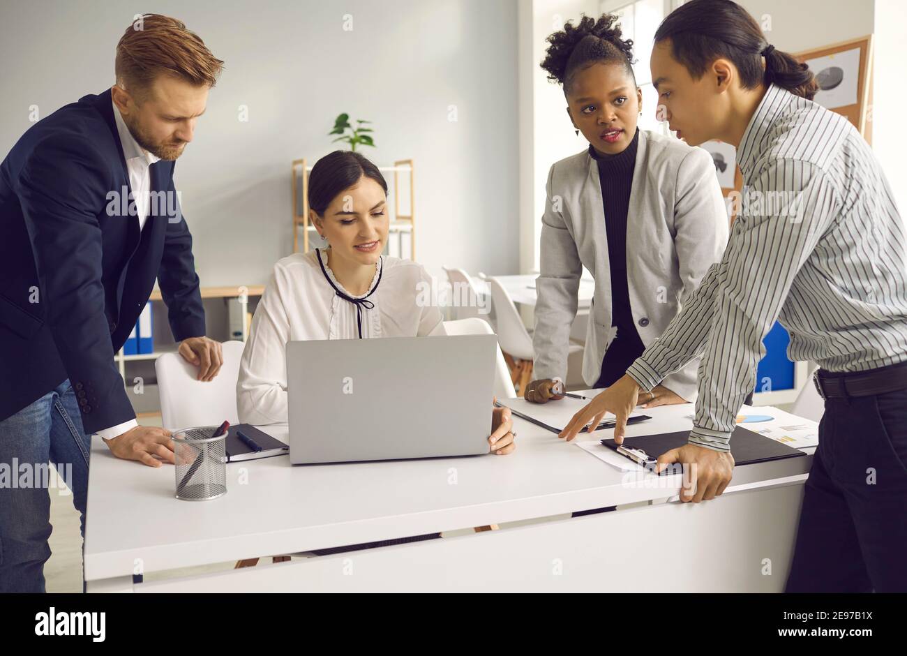 Digital marketing team using laptop and discussing customer focused ...