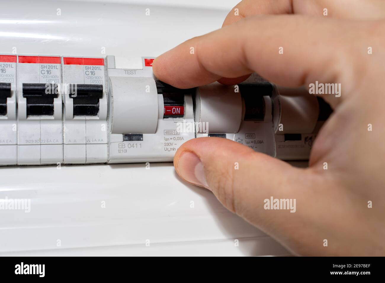 A closeup of an electrical engineer working in a power electrical panel ...