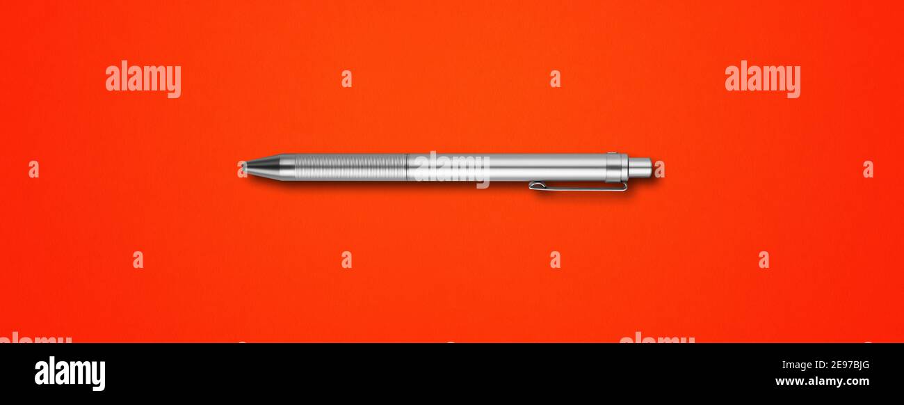 Steel metal pen isolated on red background banner Stock Photo - Alamy
