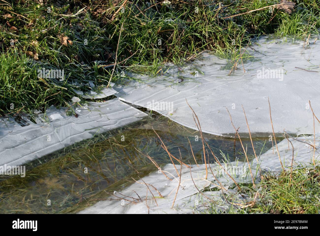 The trench is frozen over and covered with ice. It is winter and severe ...