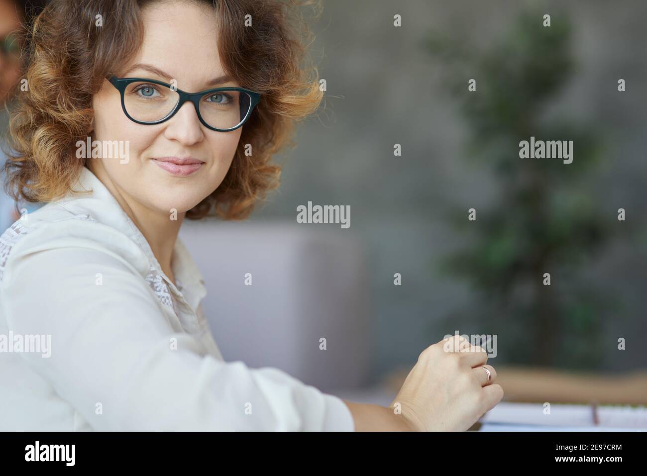 Kind teacher. Portrait of attractive young female teacher in glasses ...