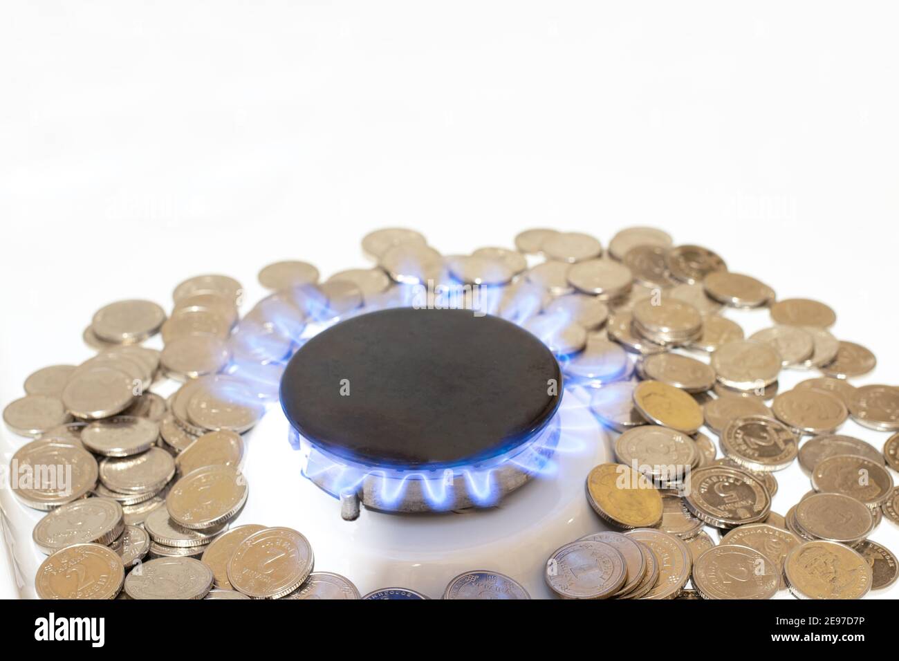 Money and gas burner on a white background with space for text. The ...