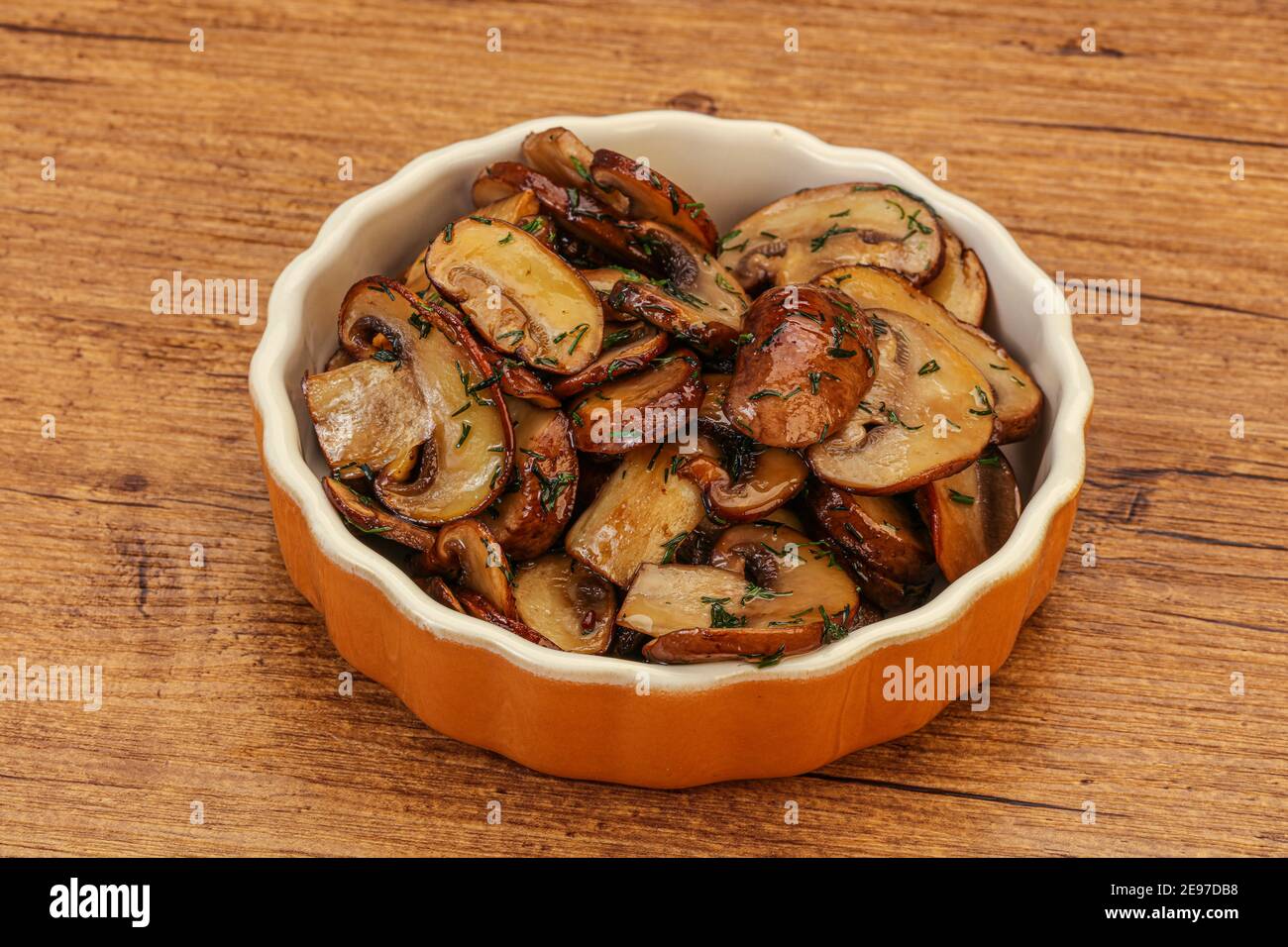Roasted champignon with herbs and spices in the bowl Stock Photo - Alamy