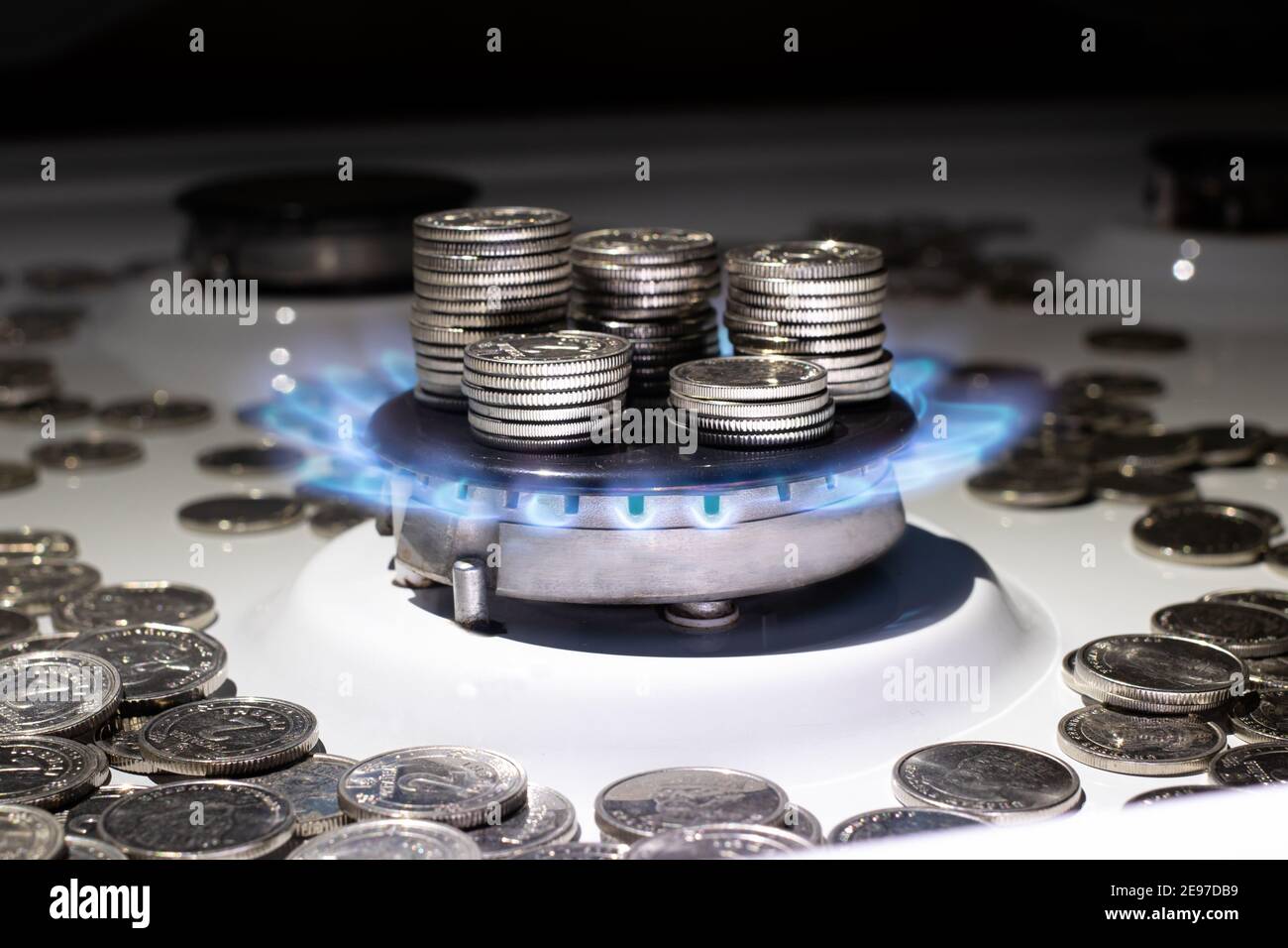 Money and gas burner on a white background with space for text. The ...