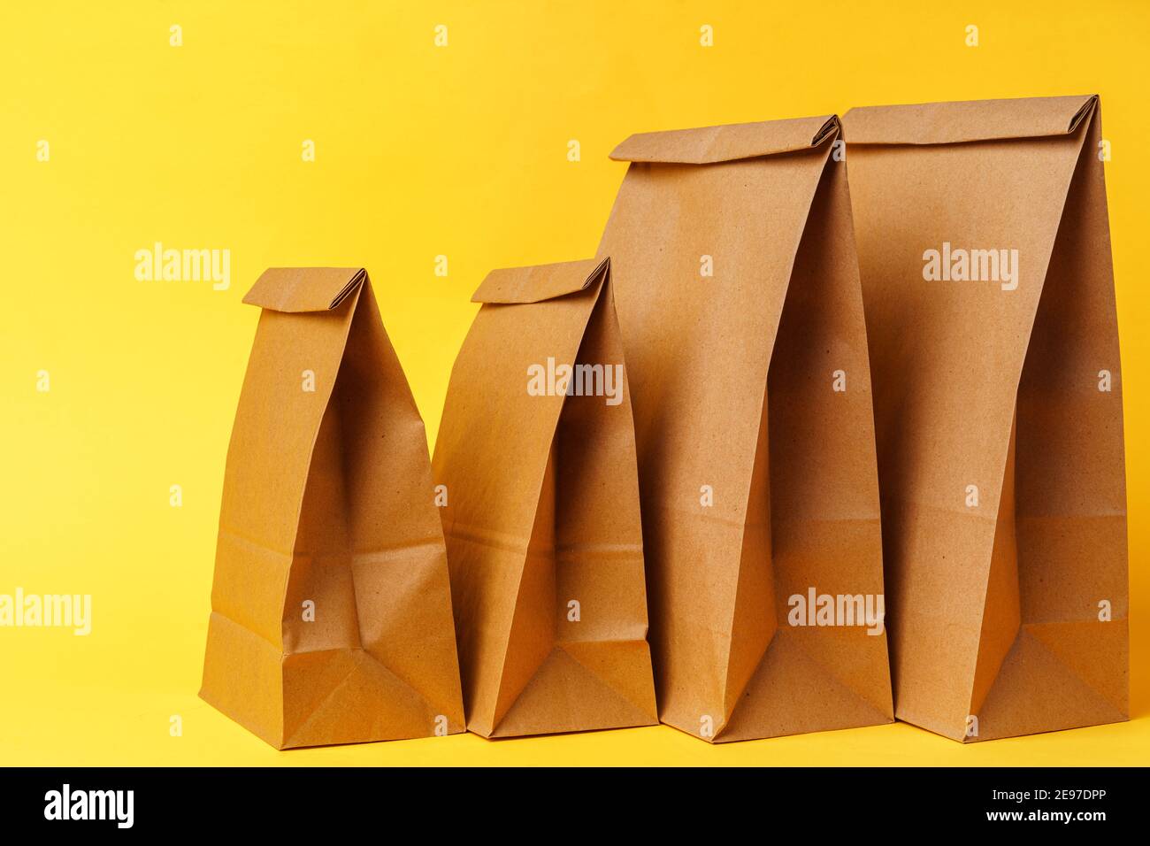 Craft packets on bright yellow paper background Stock Photo - Alamy