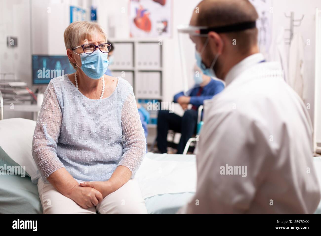 Mature patient speaking with medical staff about infection with covid19 ...