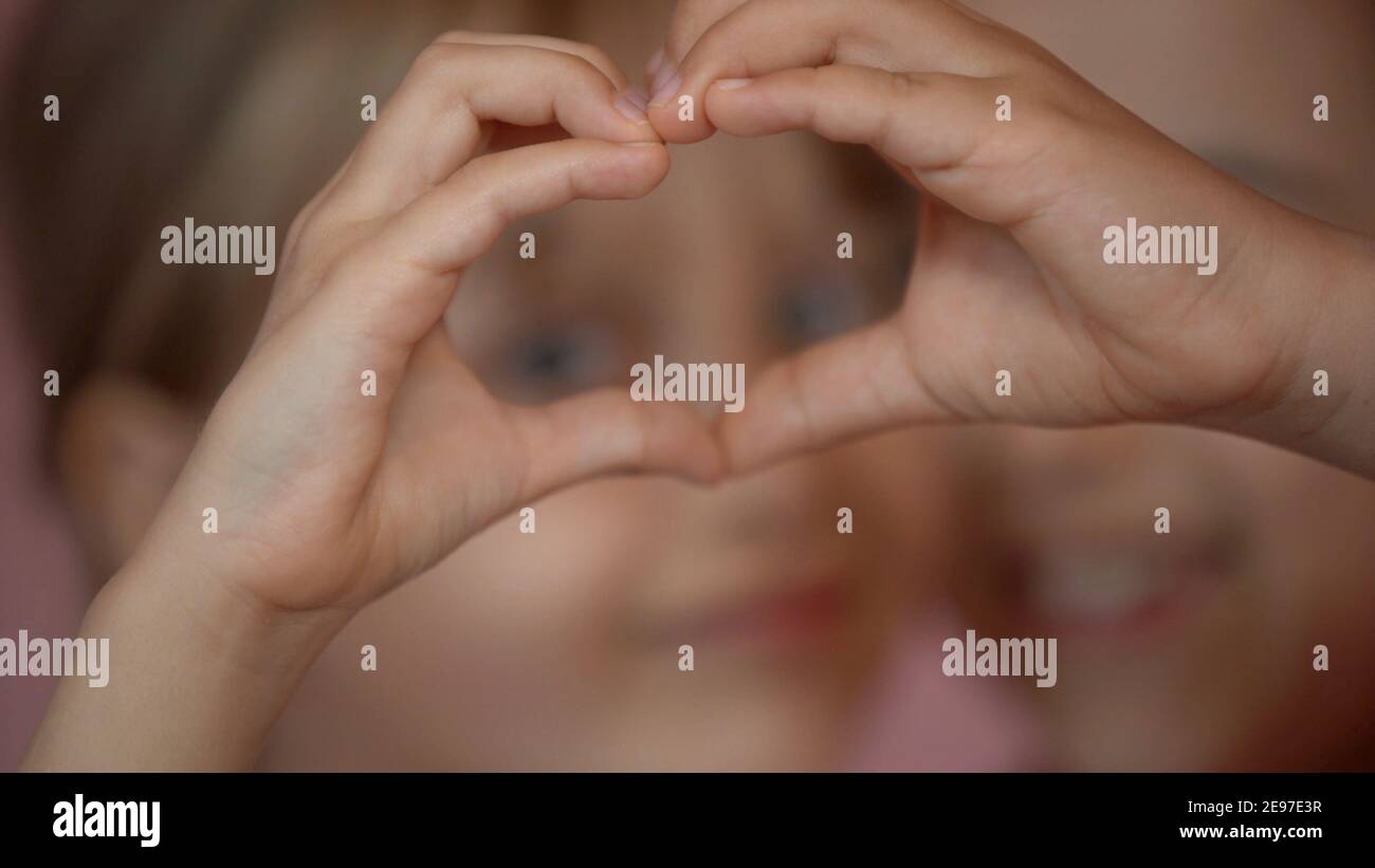 Children's hands show signs of heart Stock Photo - Alamy