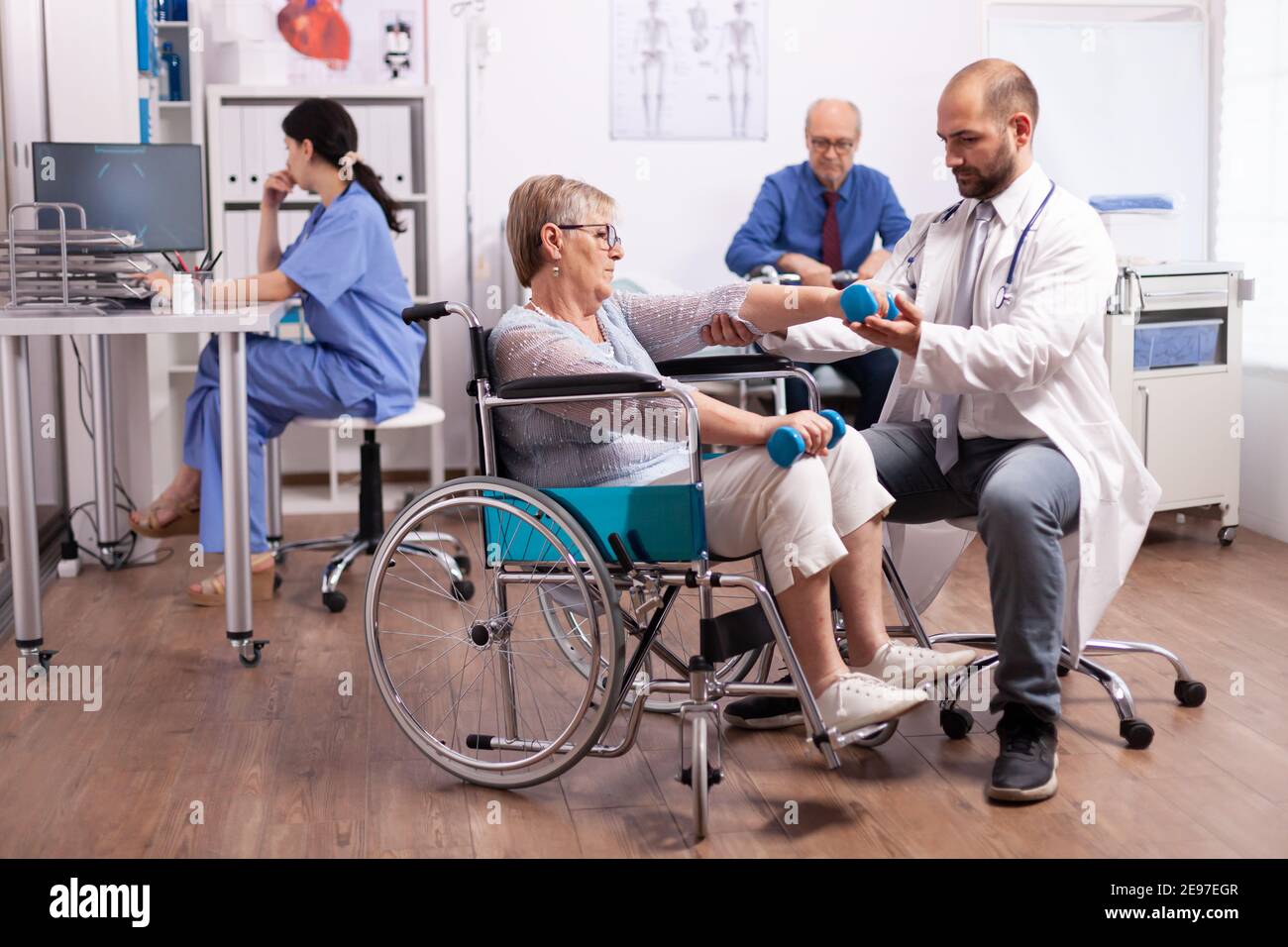 Handicapped patient getting help from physical therapist. Elderly ...