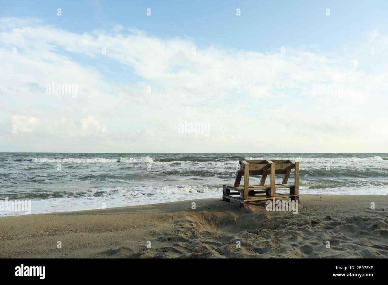 Wooden bench on sandy sea beach, space for text Stock Photo - Alamy