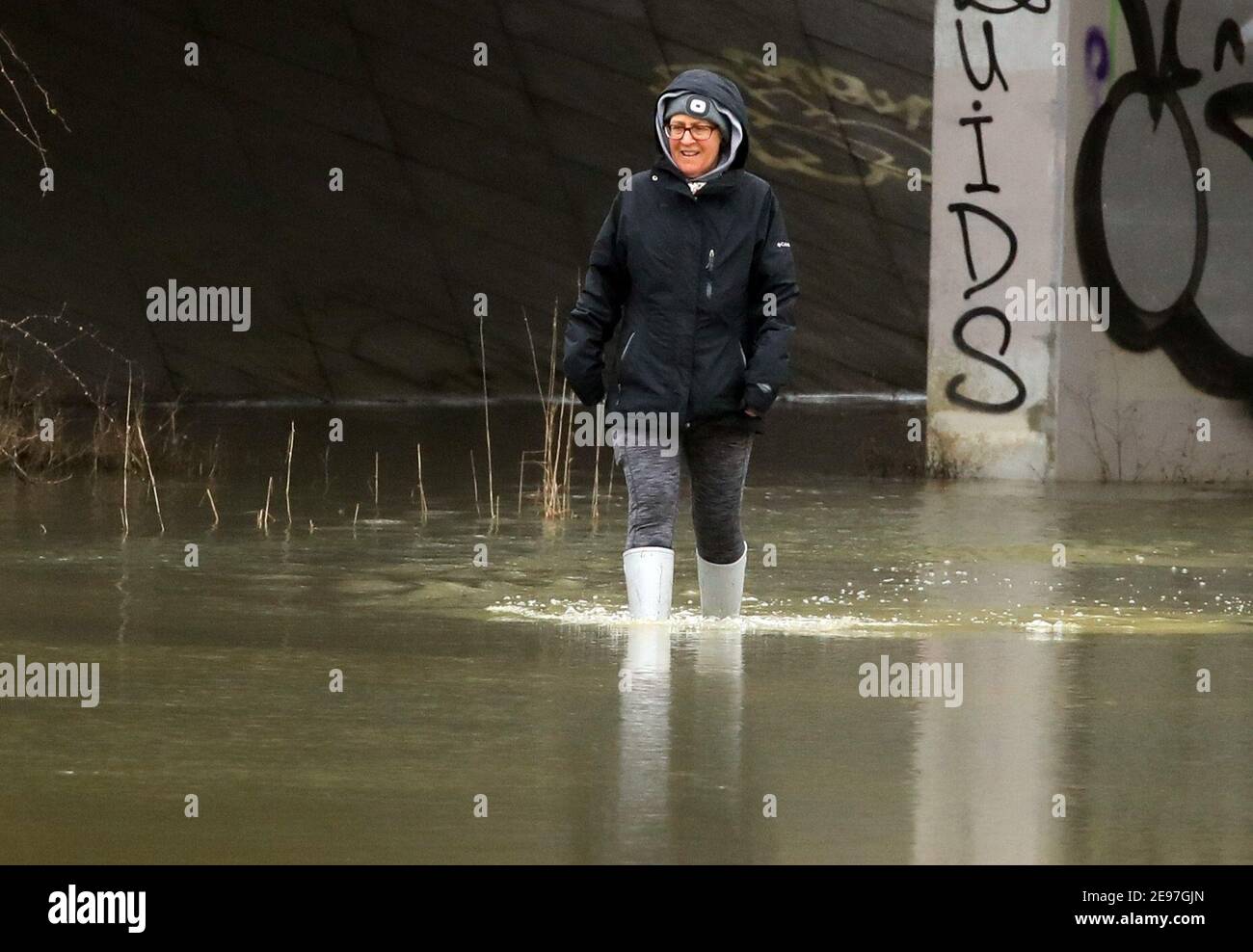 Peterborough, UK. 01st Feb, 2021. A lady wades through flooding around ...