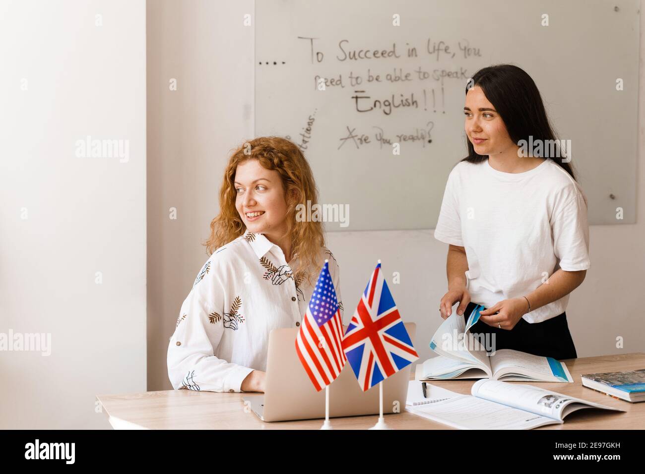 Teacher of english asks student in white class. 2 girls student answers ...