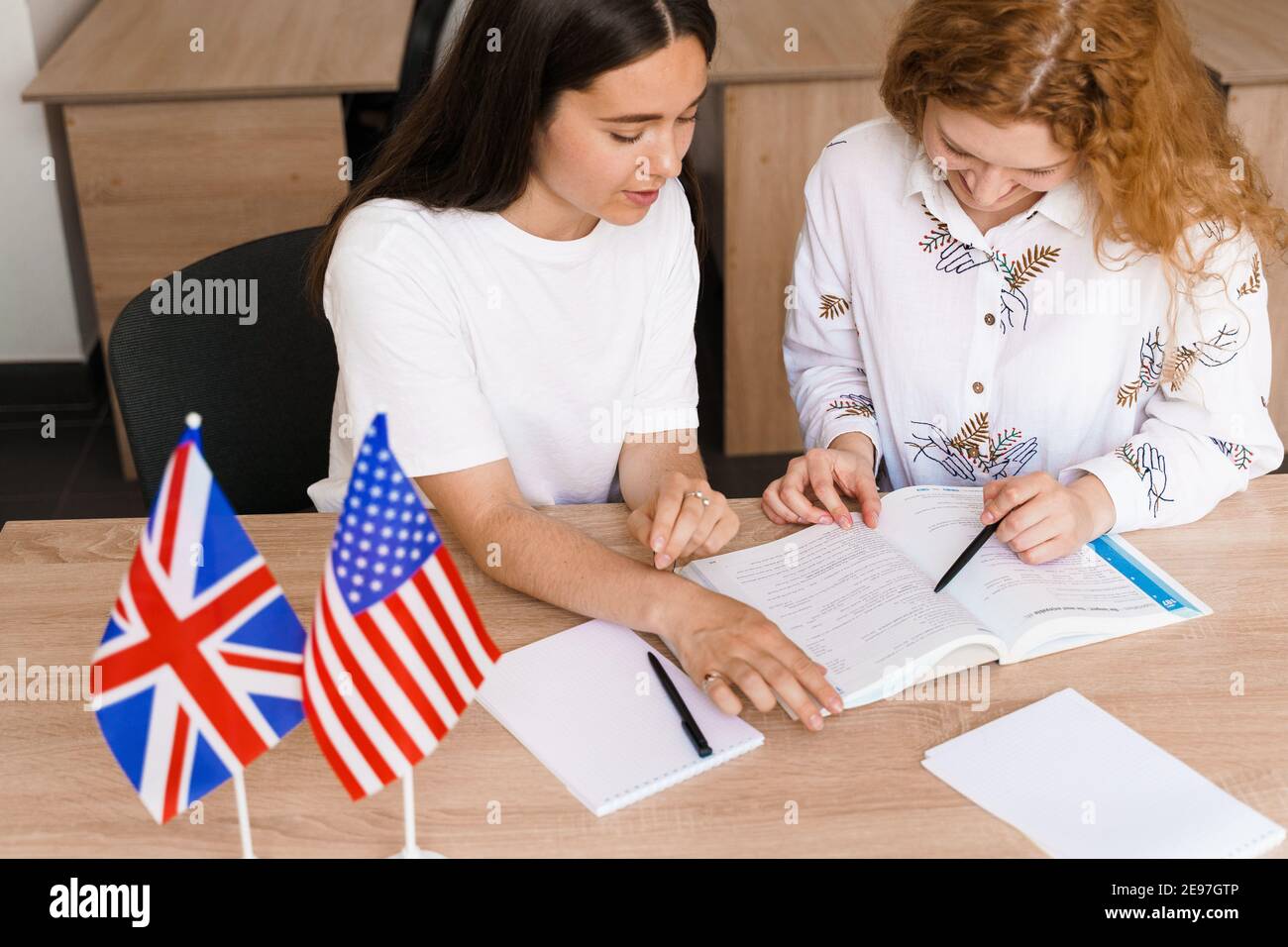 Teacher of english asks student in white class. 2 girls student answers ...