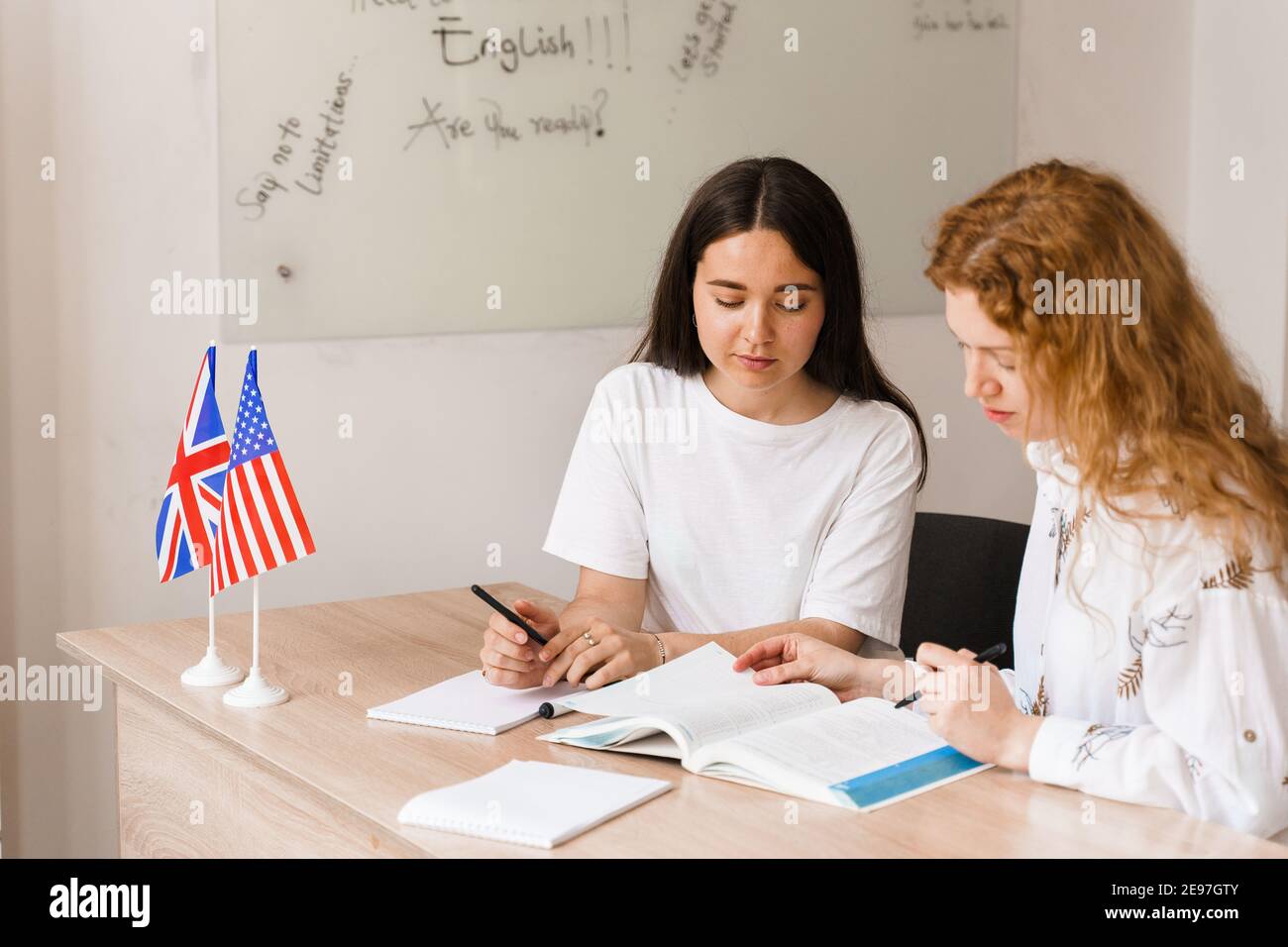 Teacher of english asks student in white class. 2 girls student answers ...