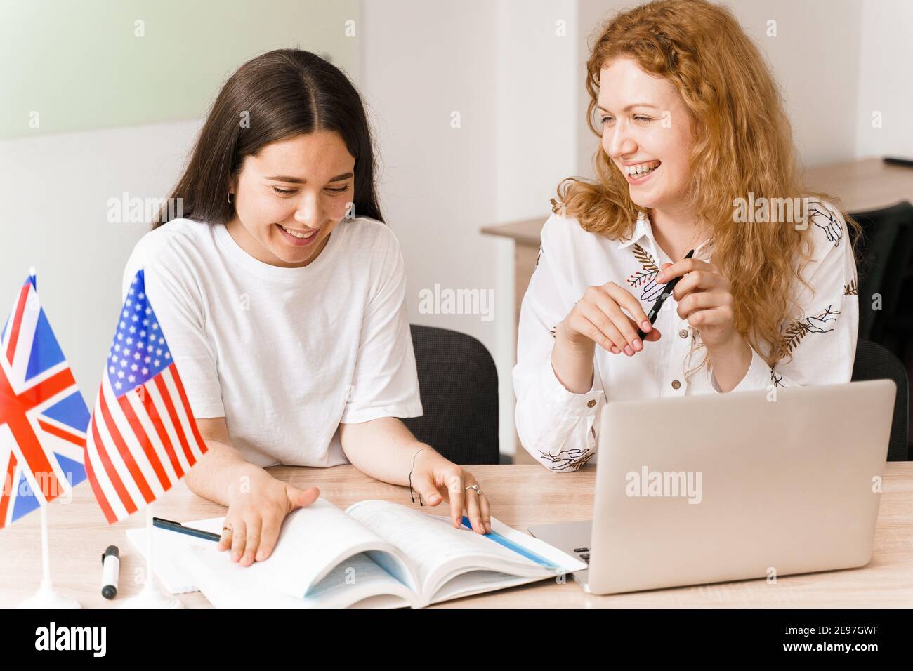 Teacher of english asks student in white class. 2 girls student answers ...