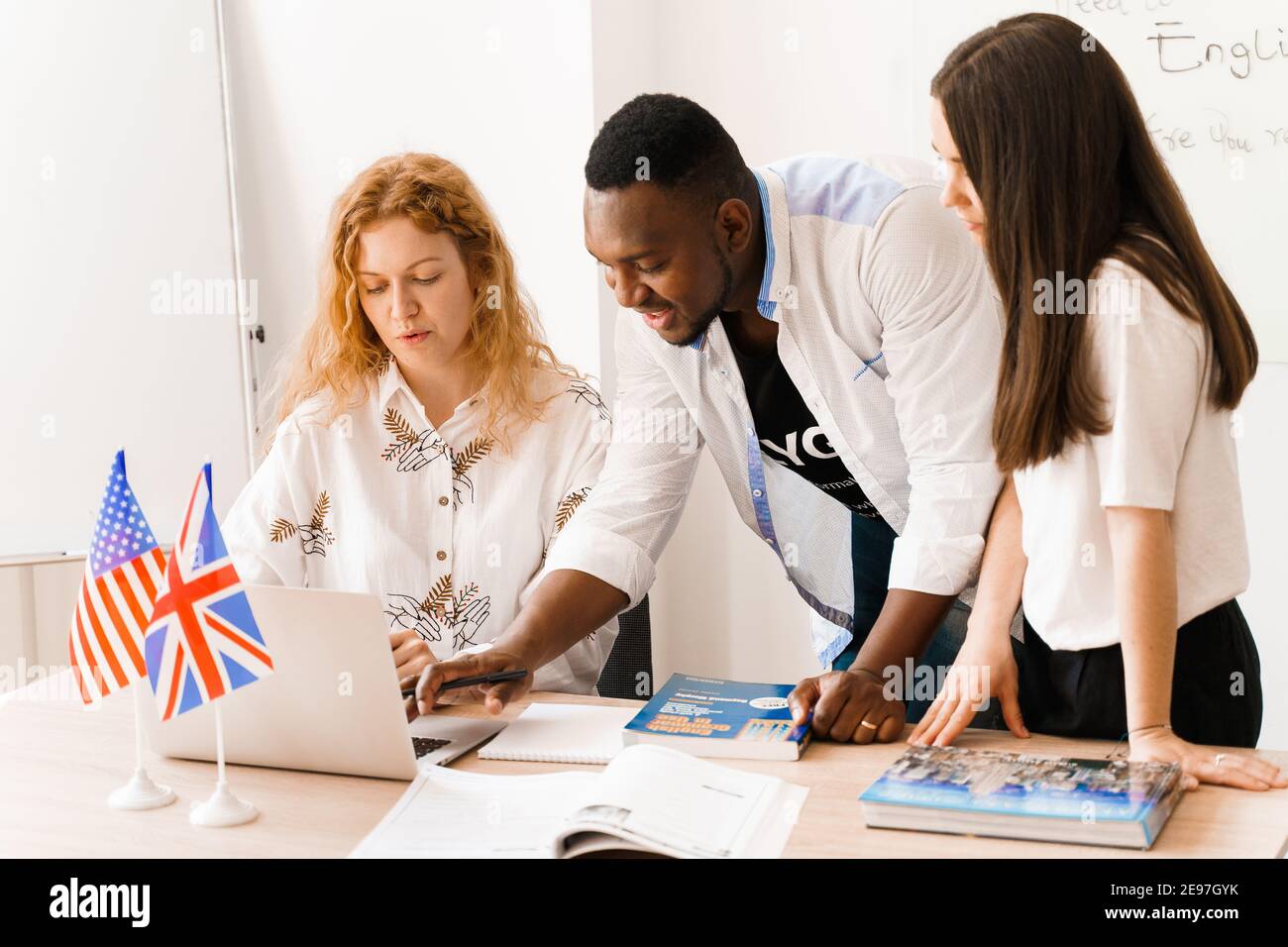 Attractive friendly-looking colleagues are working together in an ...