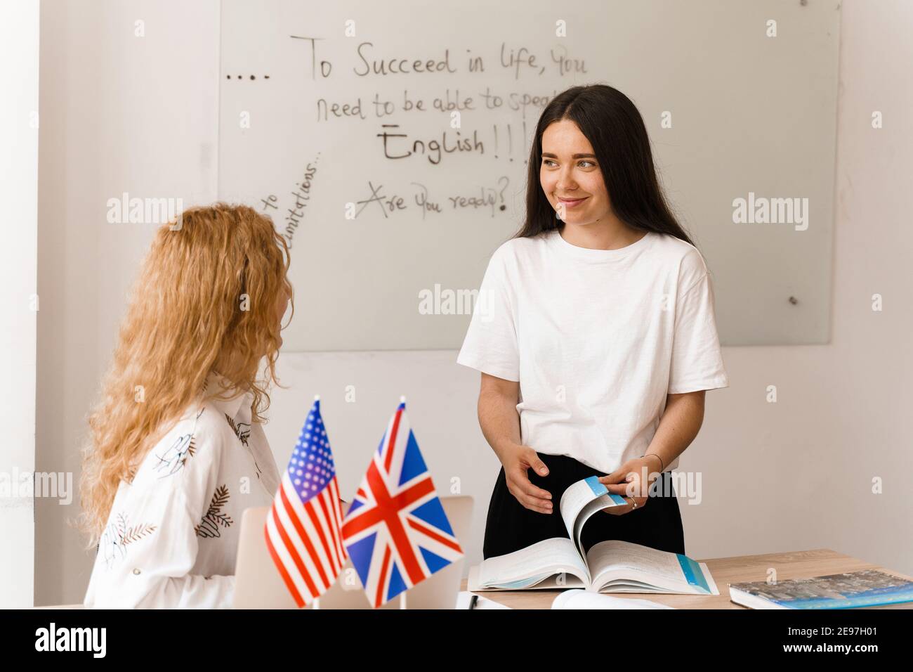 Teacher of english asks student in white class. 2 girls student answers ...