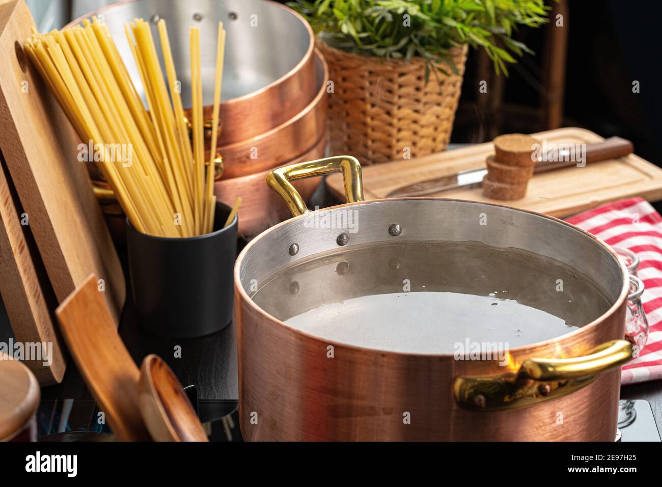 Copper pot with boiling water on a gas stove Stock Photo - Alamy