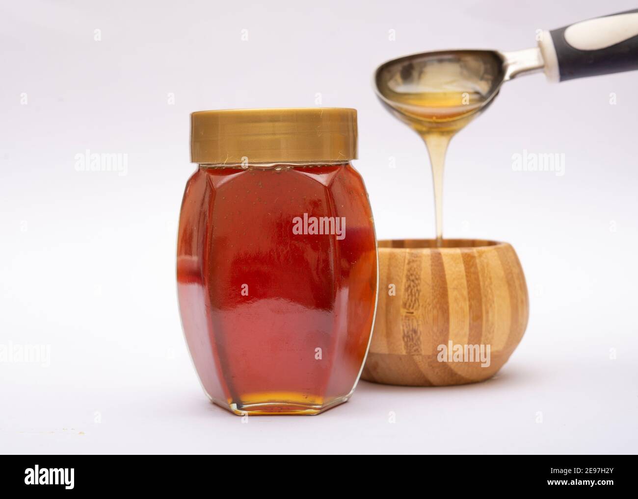 Natural honey jar filled with spoon in background Stock Photo - Alamy